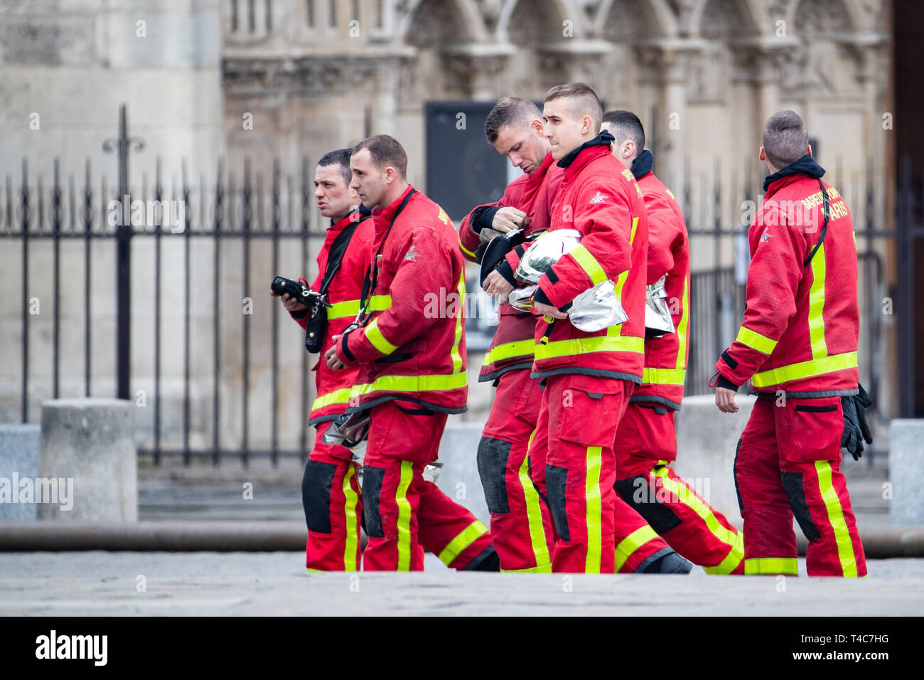 Paris, France. 16th Apr 2019. Firefighters walk with their helmets ...