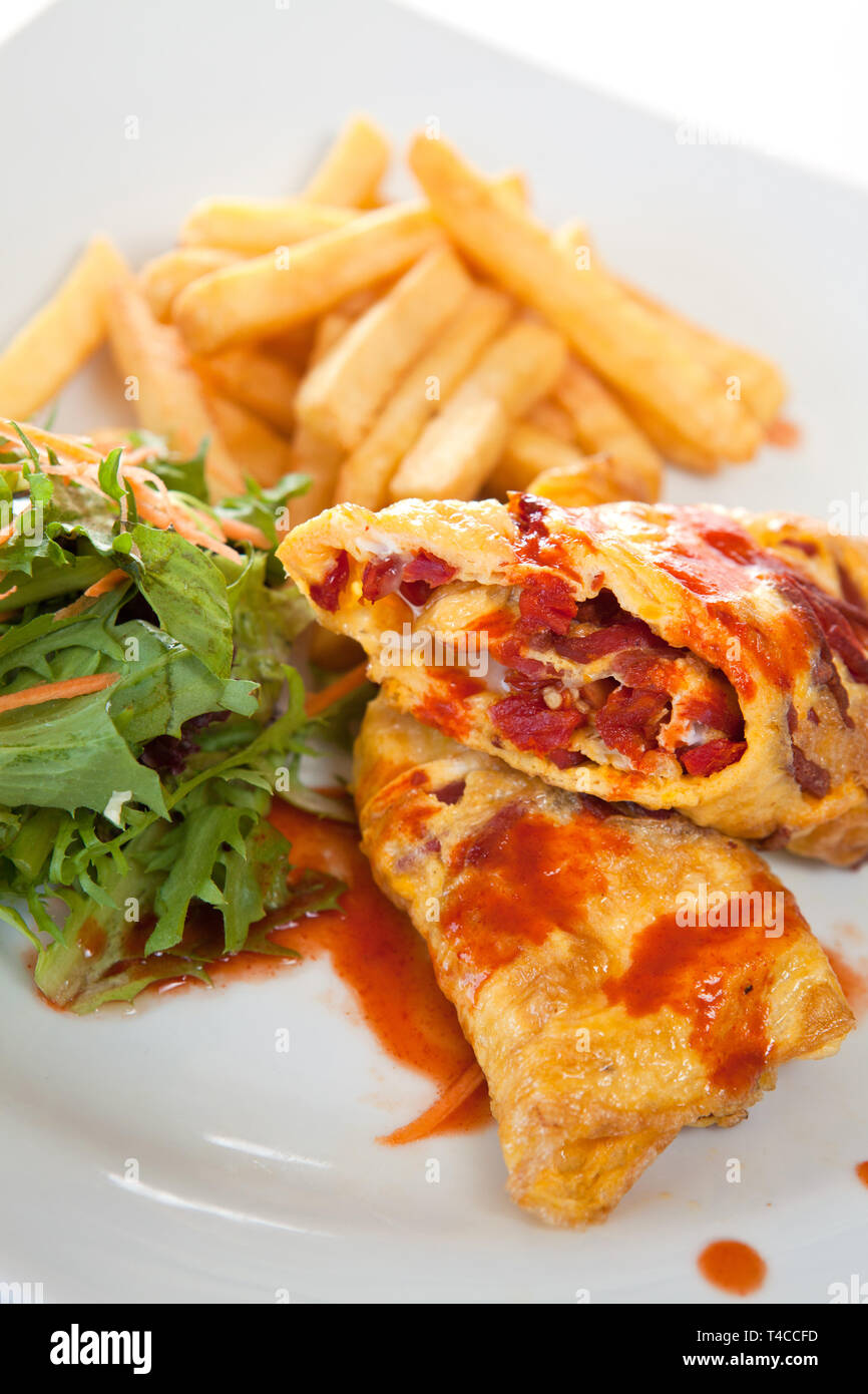 Stuffed crepes with salad and fries Stock Photo - Alamy