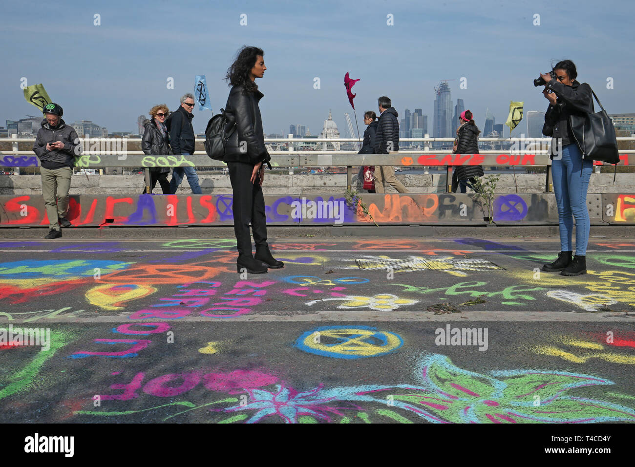 People take photographs following an Extinction Rebellion protest on ...