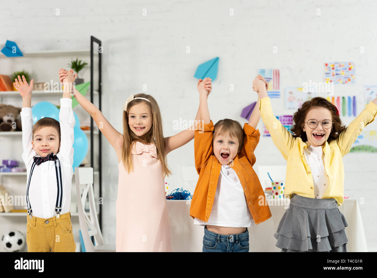 Kids girls raising hands hi-res stock photography and images - Alamy