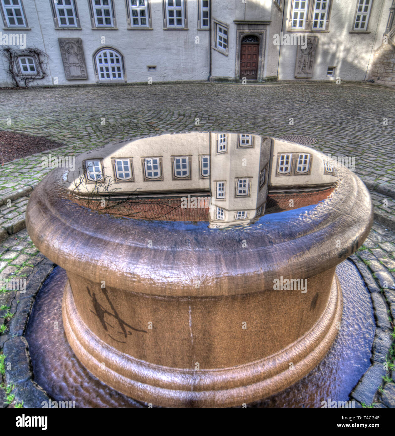Fountain in the courtyard of a castle ,view of the reflection on the ...