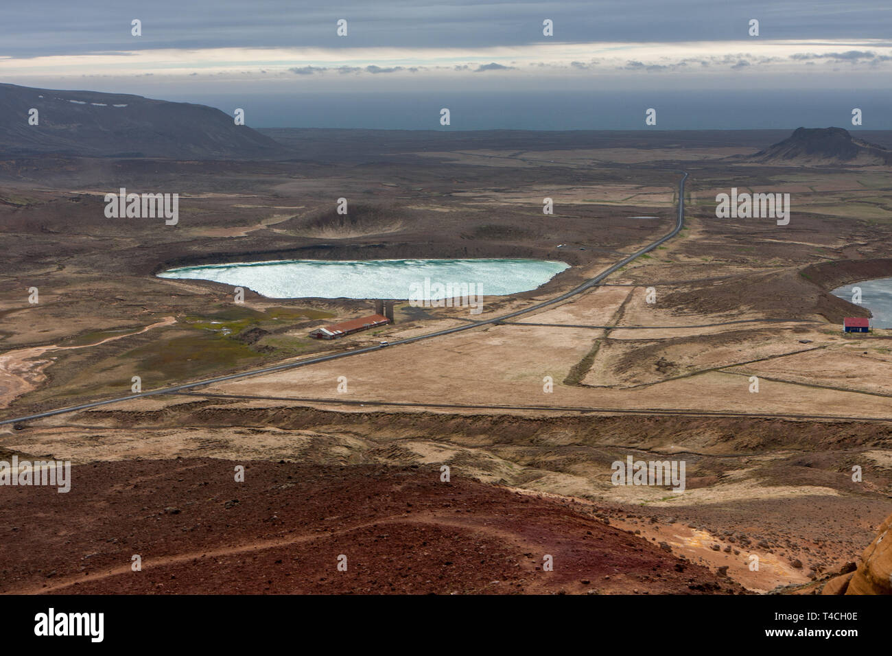Landscape with geothermal zone in storm with lake and building ...