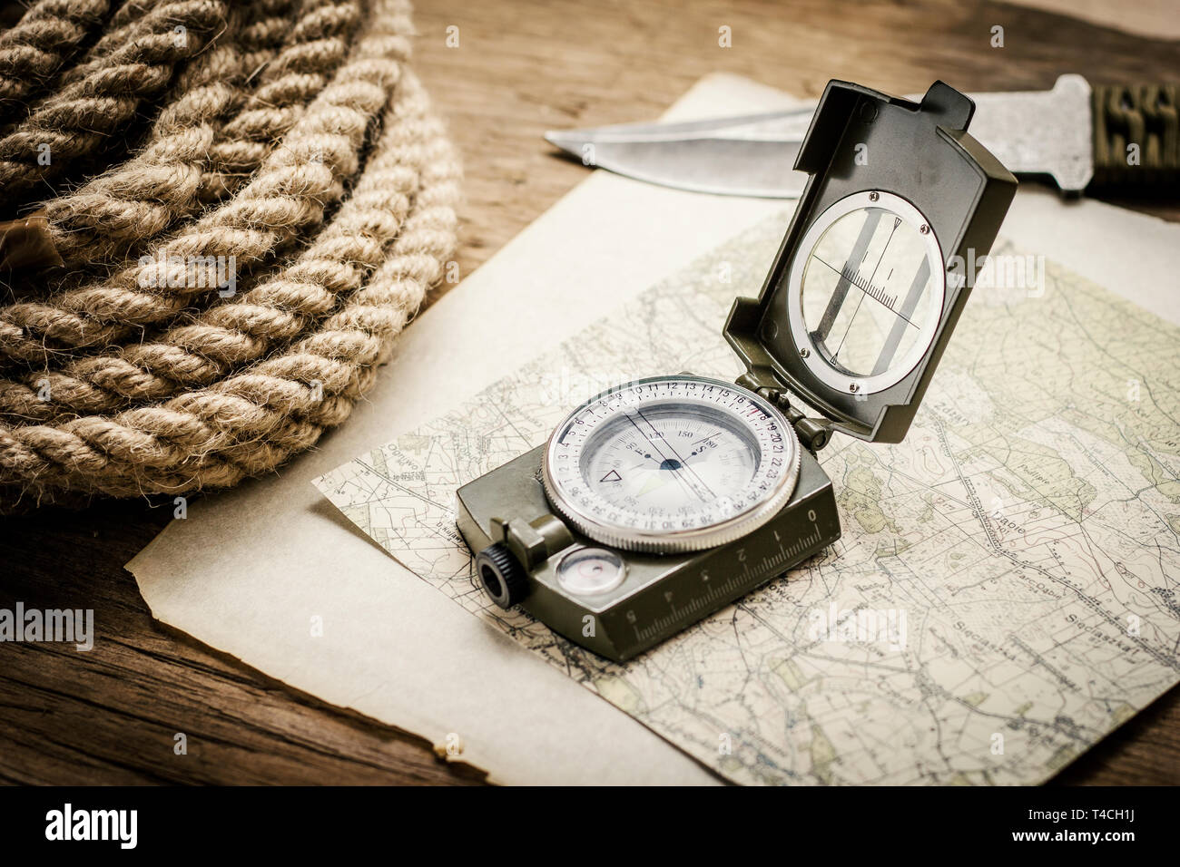 line, old paper, map, compass and a knife on a wooden table Stock Photo ...