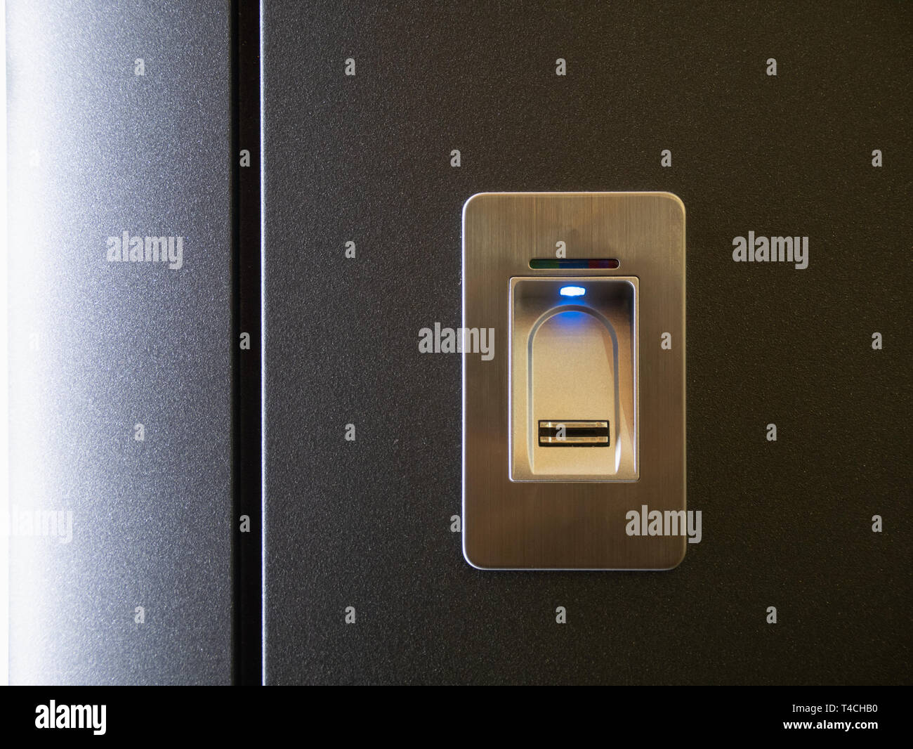 closeup fingerprint sensor on modern armored metallic black door and ...