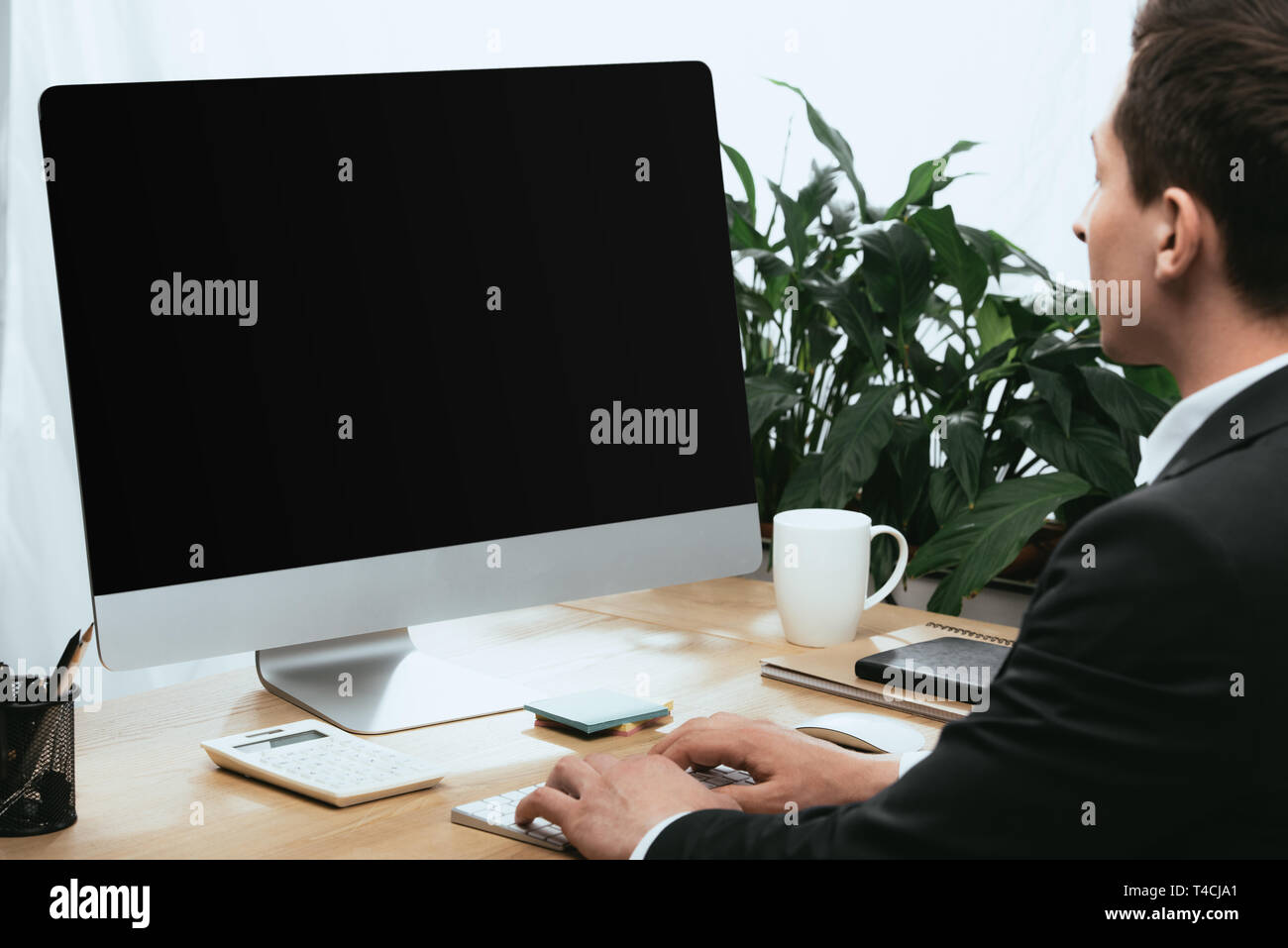 adult man in suit using computer with blank screen and copy space Stock ...