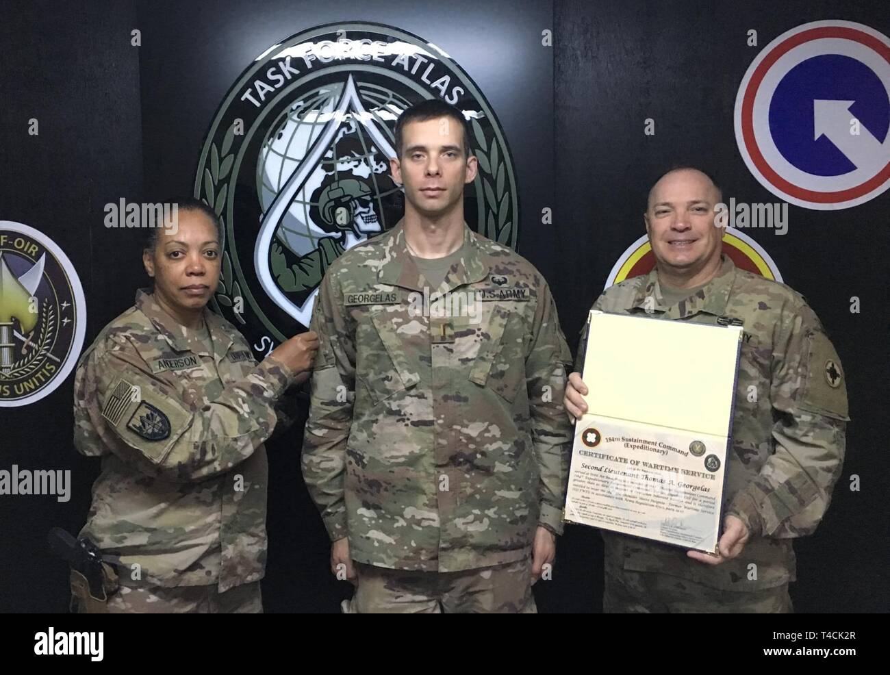 2nd Lt. Thomas Georgelas, 184th Sustainment Command, is presented his ...