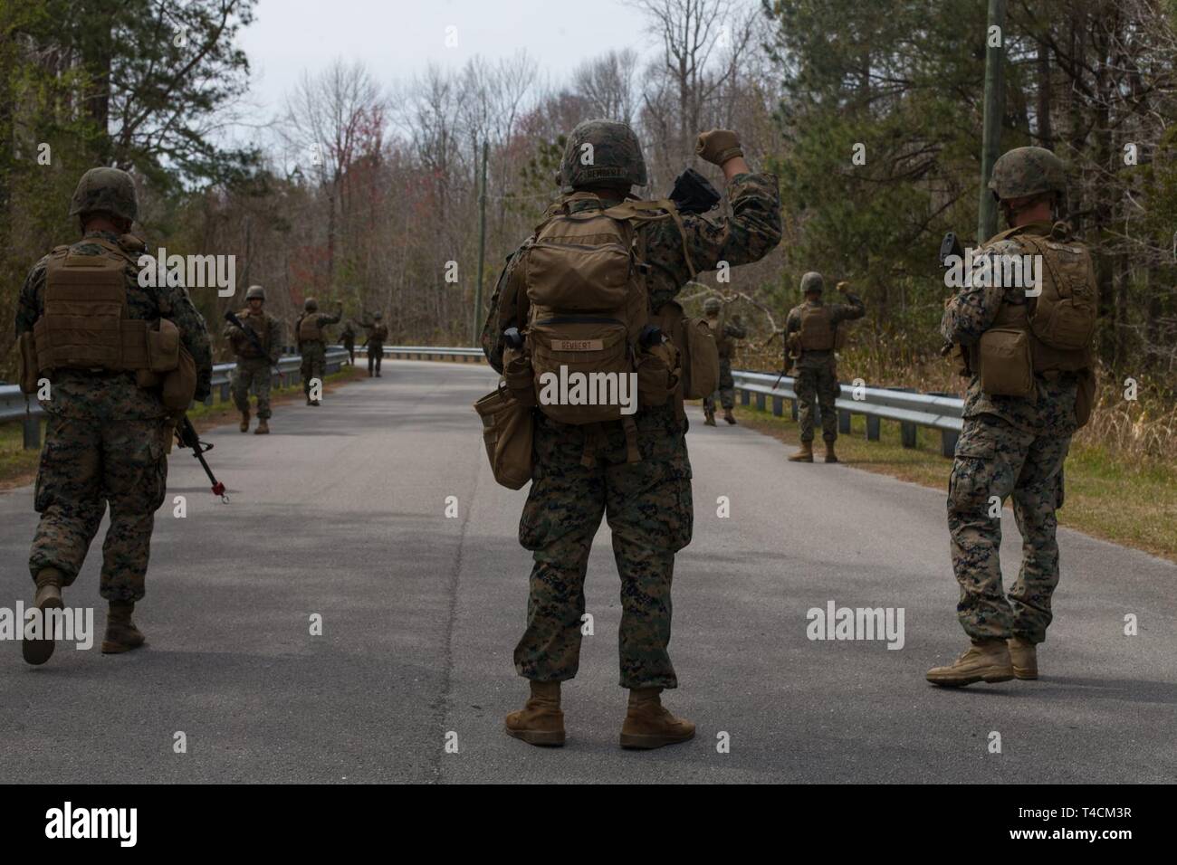 U.S. Marine Corps Cpl. Stewart Rembert, center, a squad leader with ...
