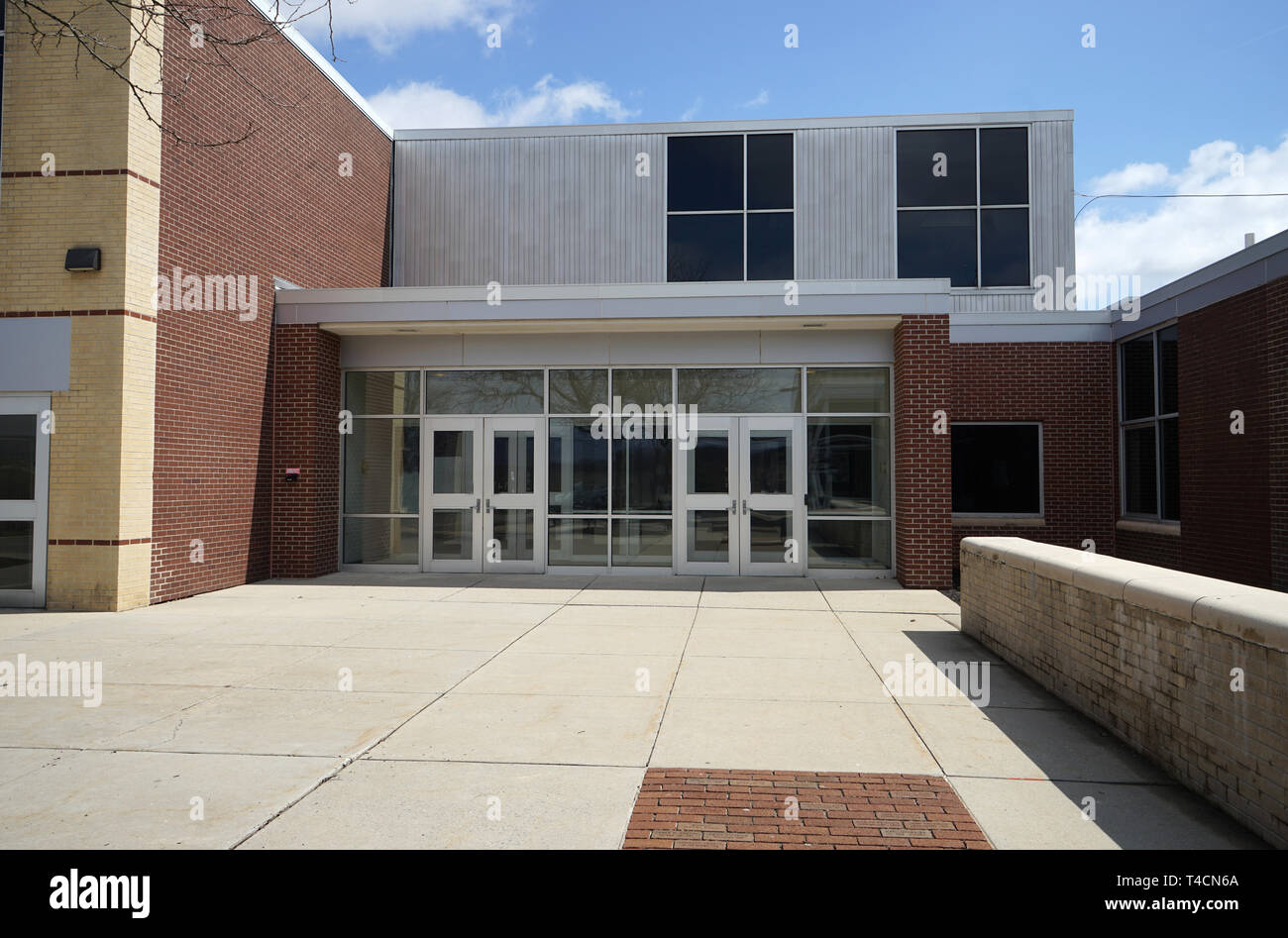 Many entry doors for a school building. This exterior view of the ...