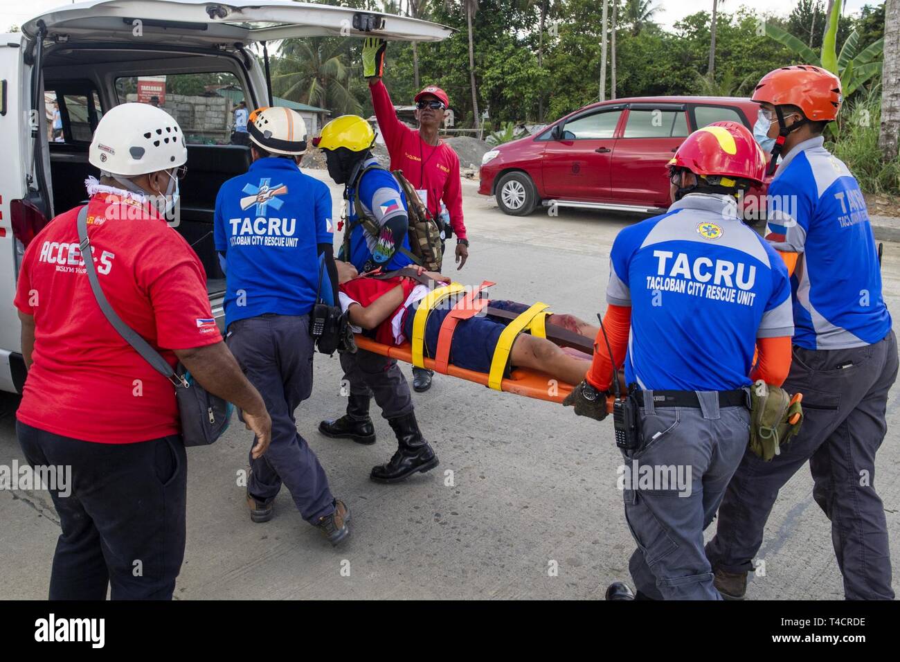 Philippines (March 21, 2019) – Tacloban City Rescue Unit personnel carry a victim with simulated ...
