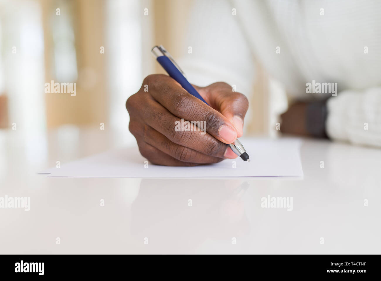 Black man writing on notepad hand hi-res stock photography and images ...