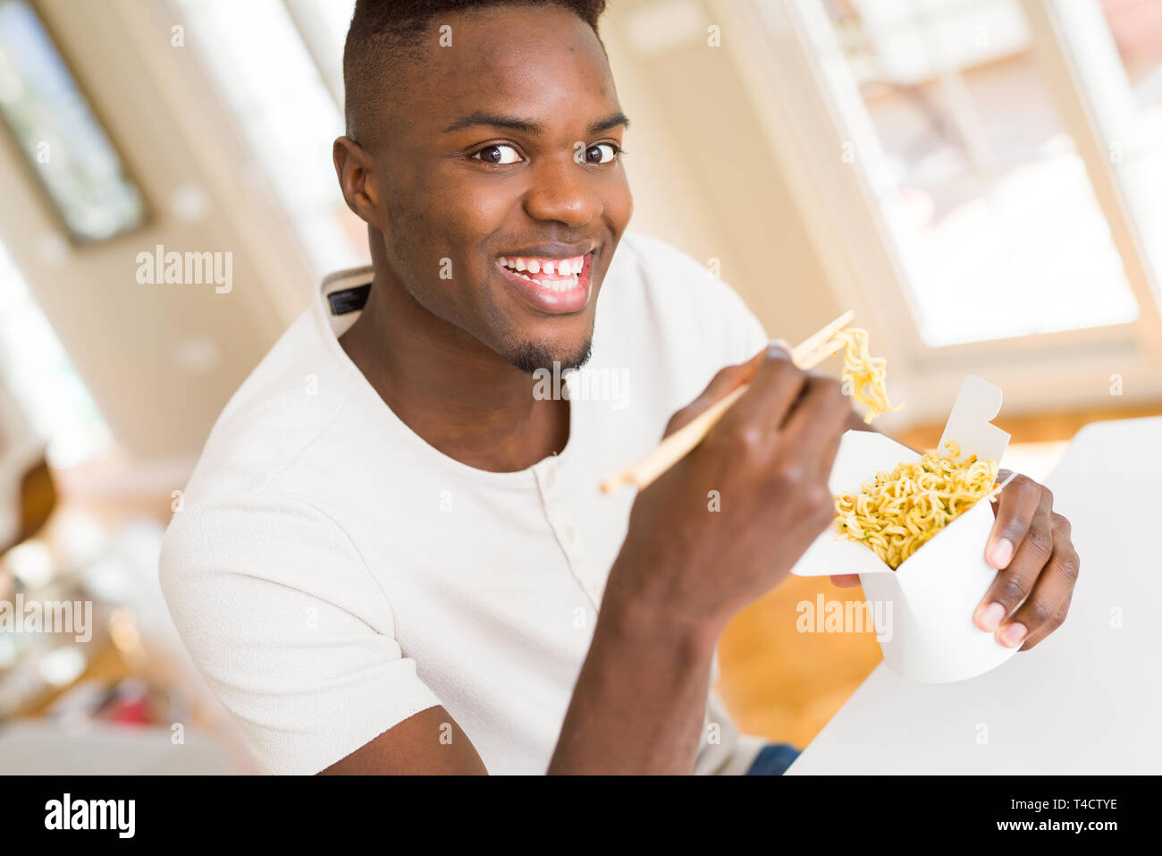 African eating noodles hi-res stock photography and images - Alamy