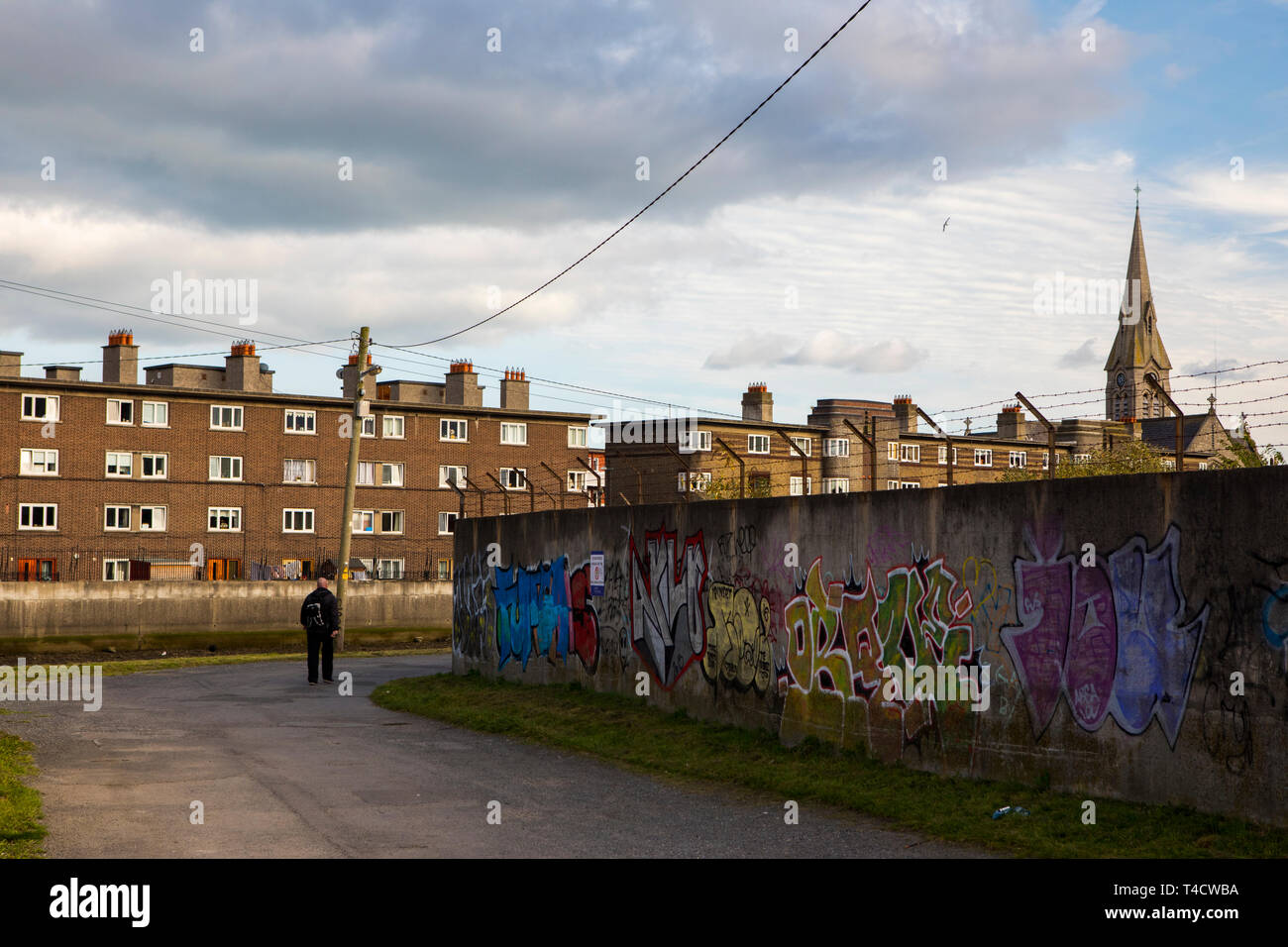 Back streets of Dublin with church, flats and graffiti-covered walls ...