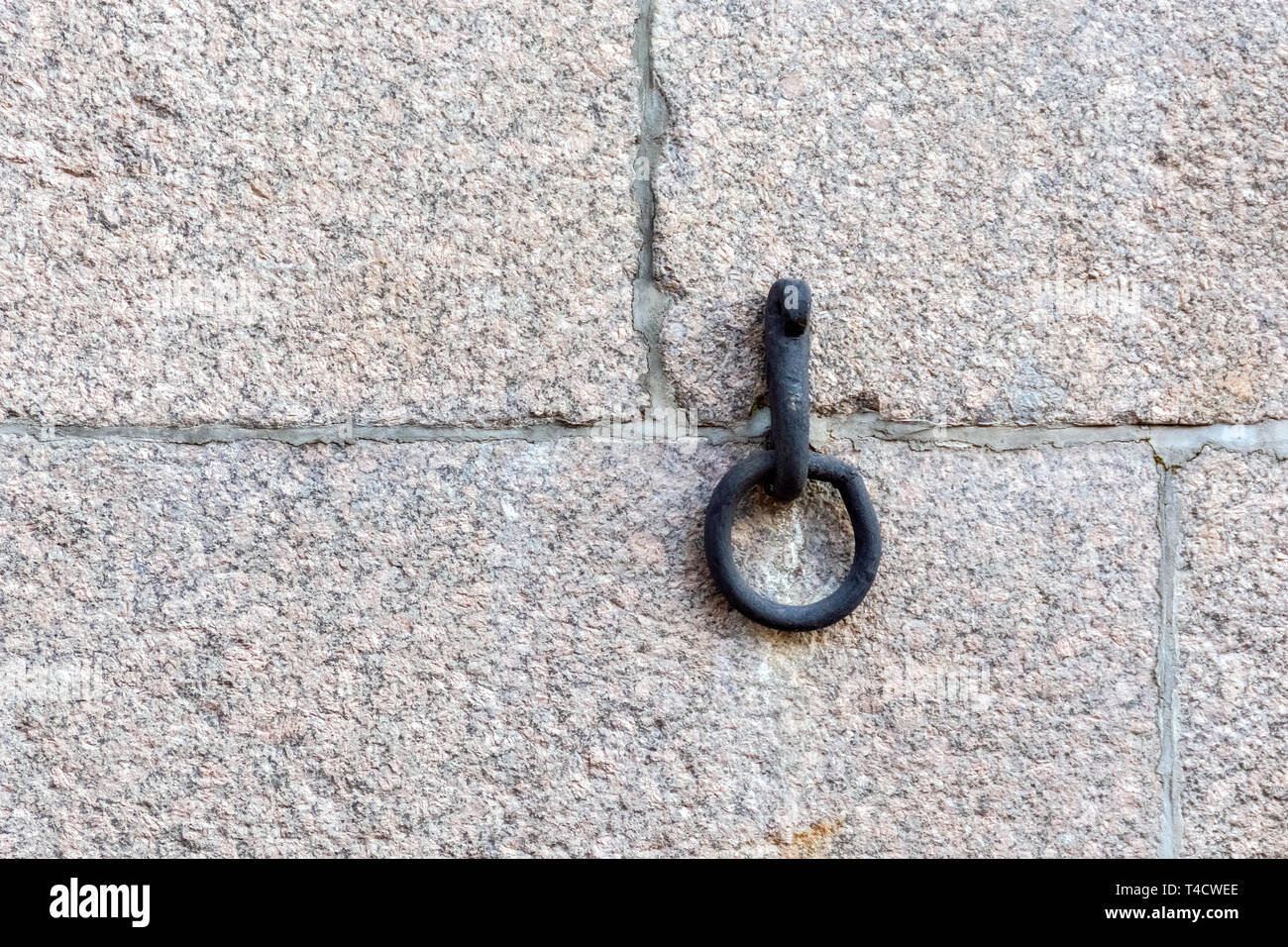 Cast iron ring embedded in the stone granite embankment for Parking ...