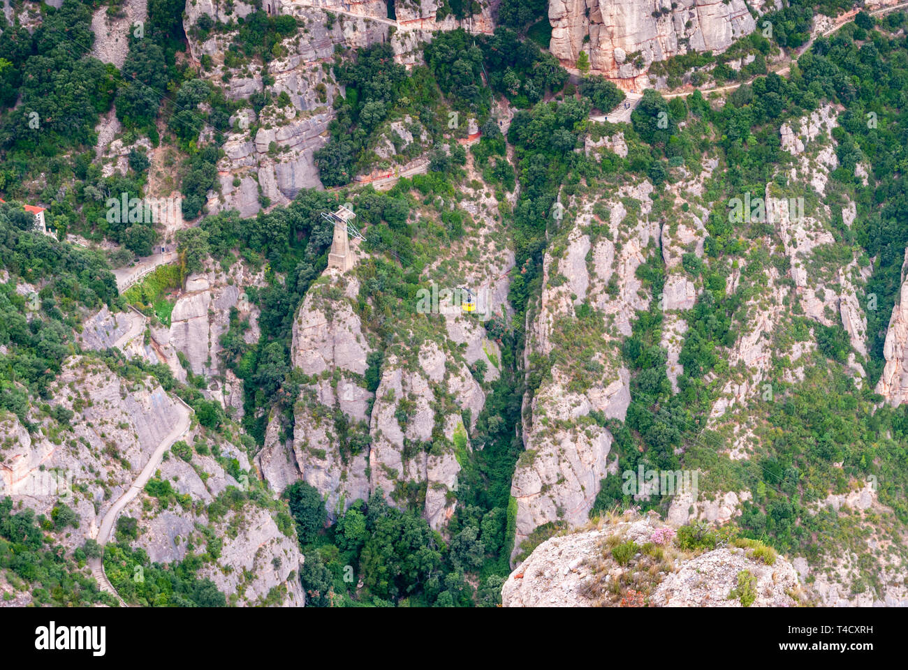 Yellow cable car in the Aeri de Montserrat rise to de Montserrat Abbey ...