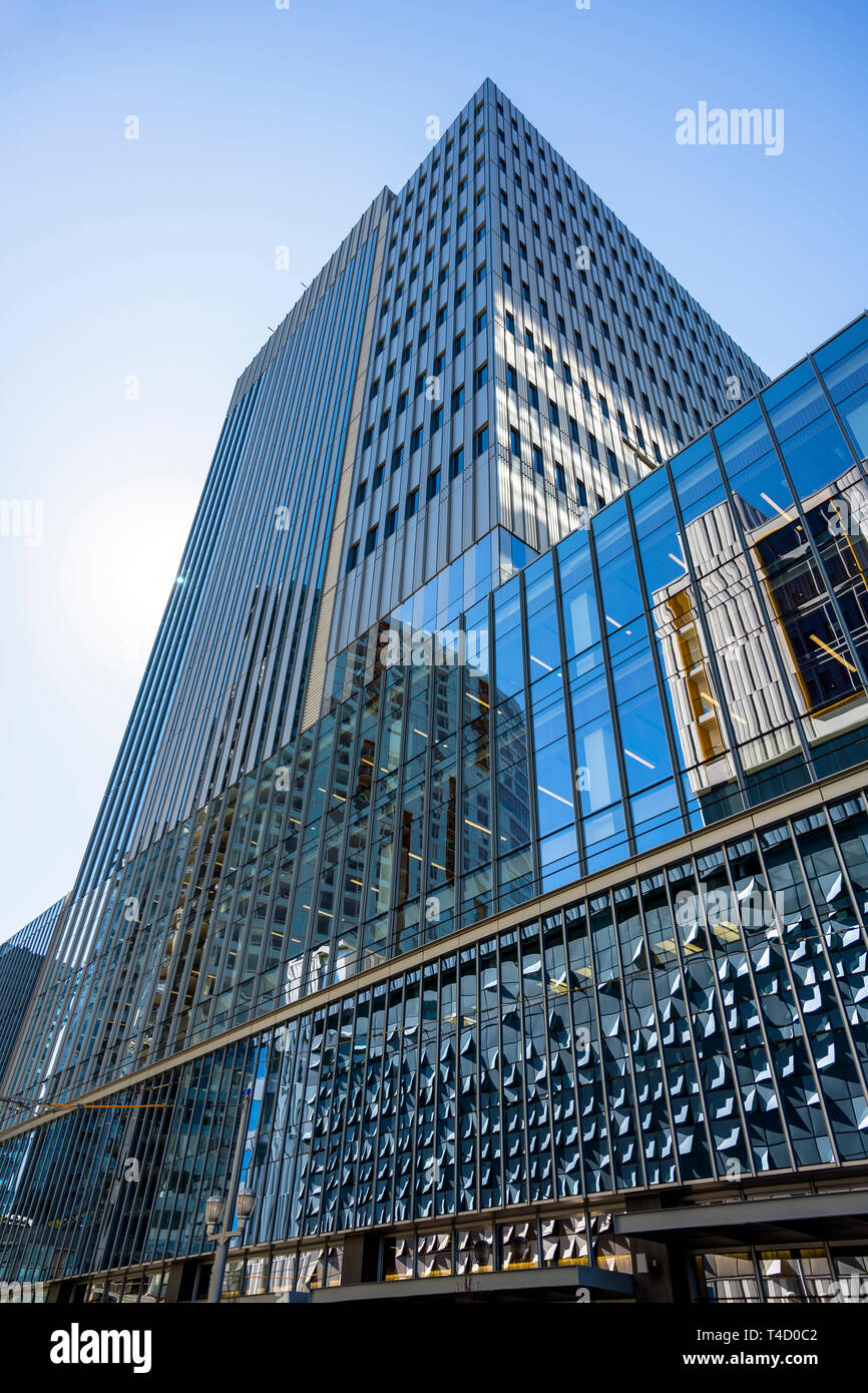 Skyscraper with avant-garde architecture with tinted glass lining in a ...