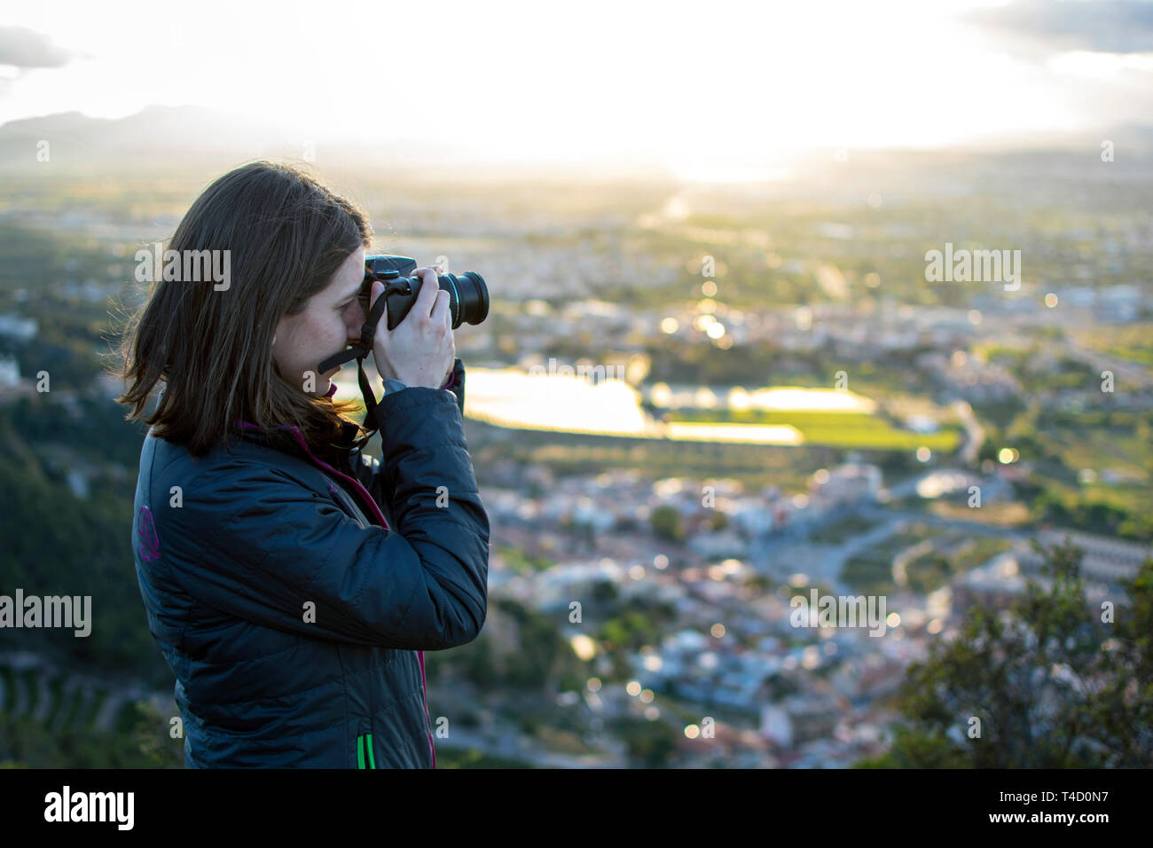 Murcia, Spain April 9, 2019. Young photographer woman hiking and taking ...