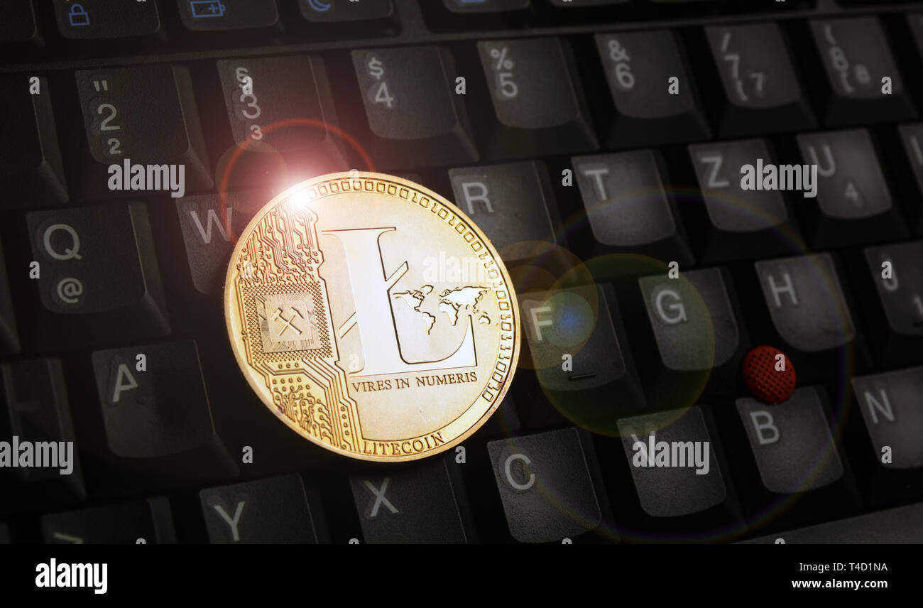 Golden Litecoin LTC coin on a black keyboard Stock Photo - Alamy