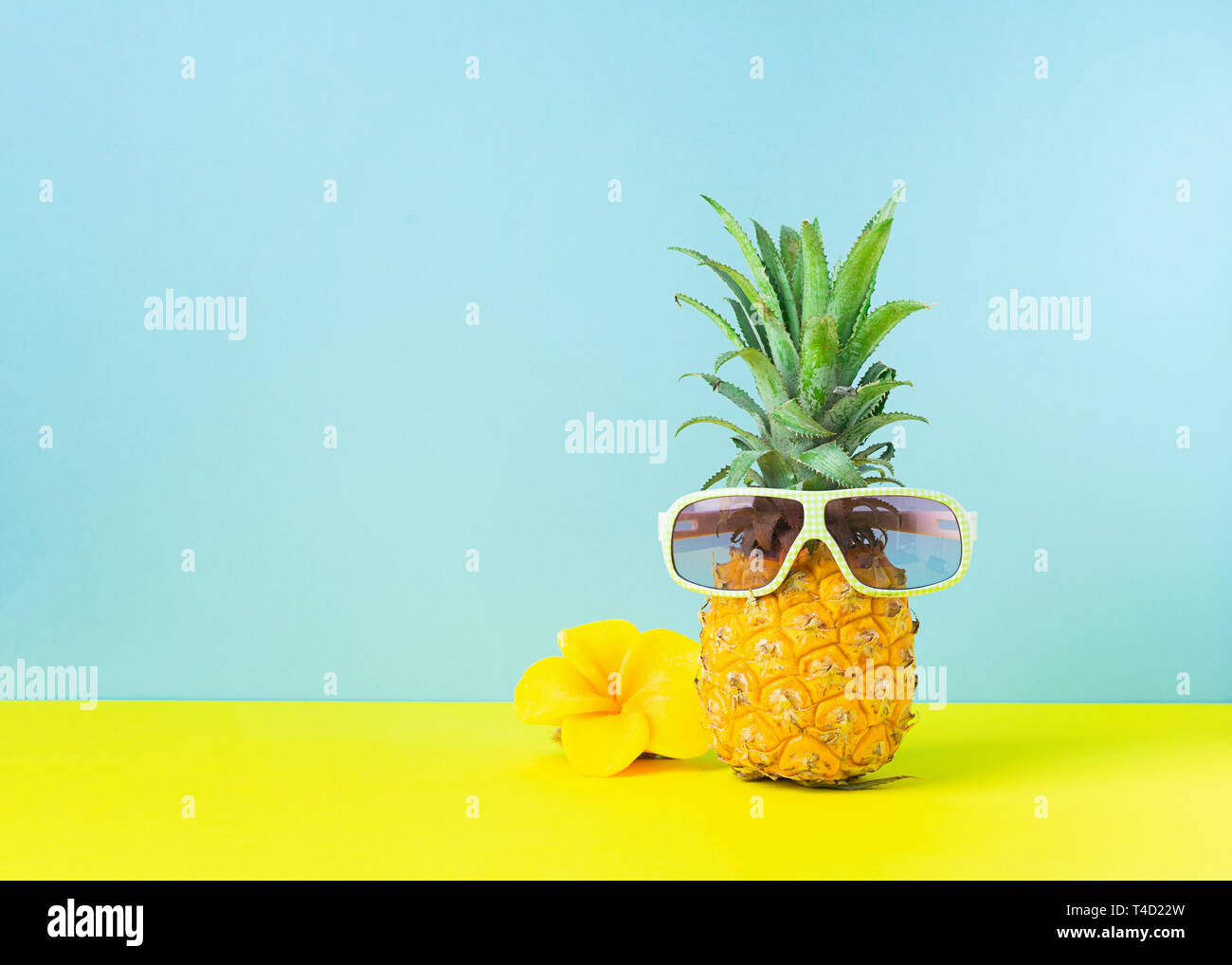 Funny cute pineapple with glasses on bright yellow blue background ...