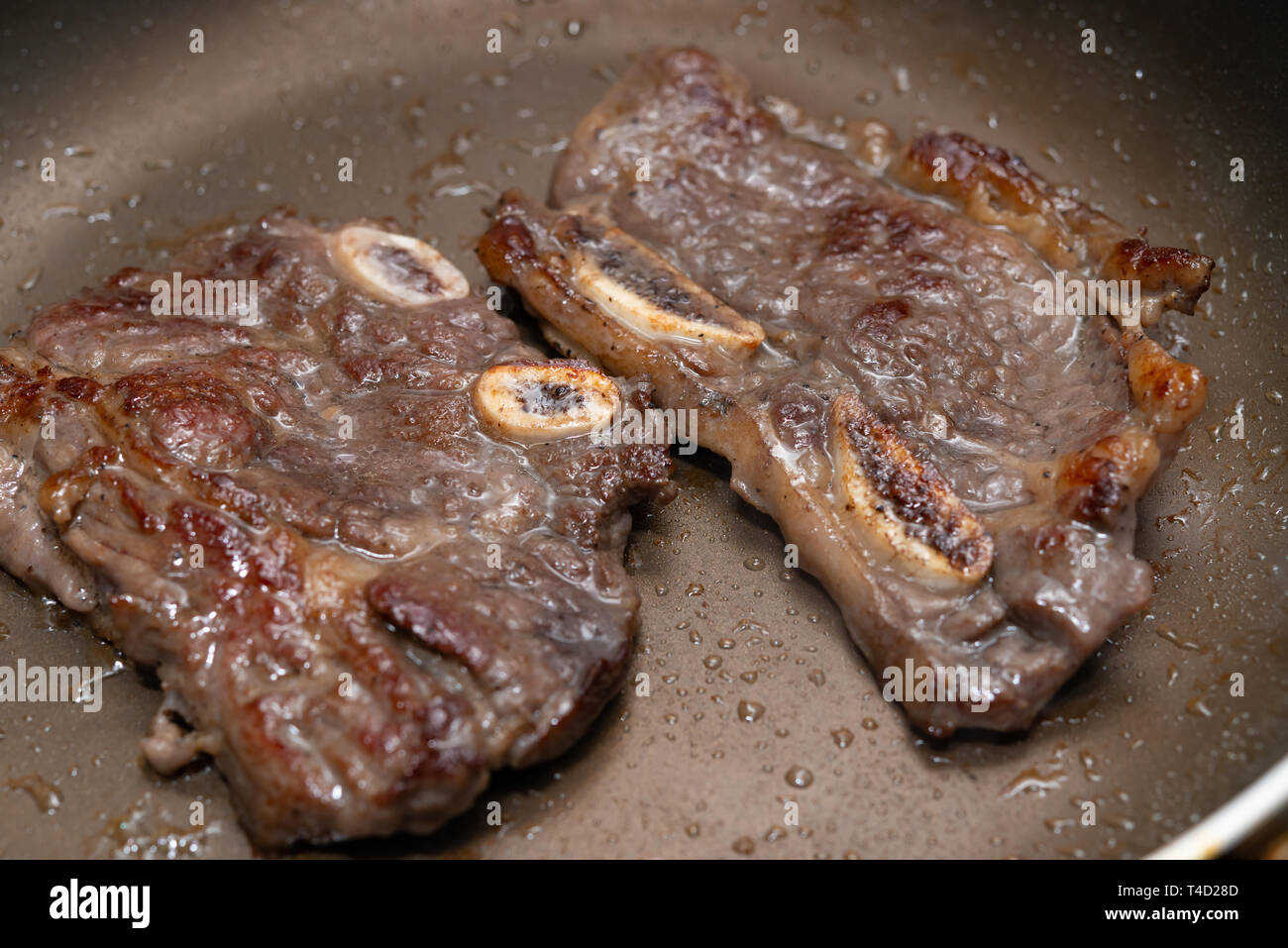 Two pieces steak on pan hi-res stock photography and images - Alamy