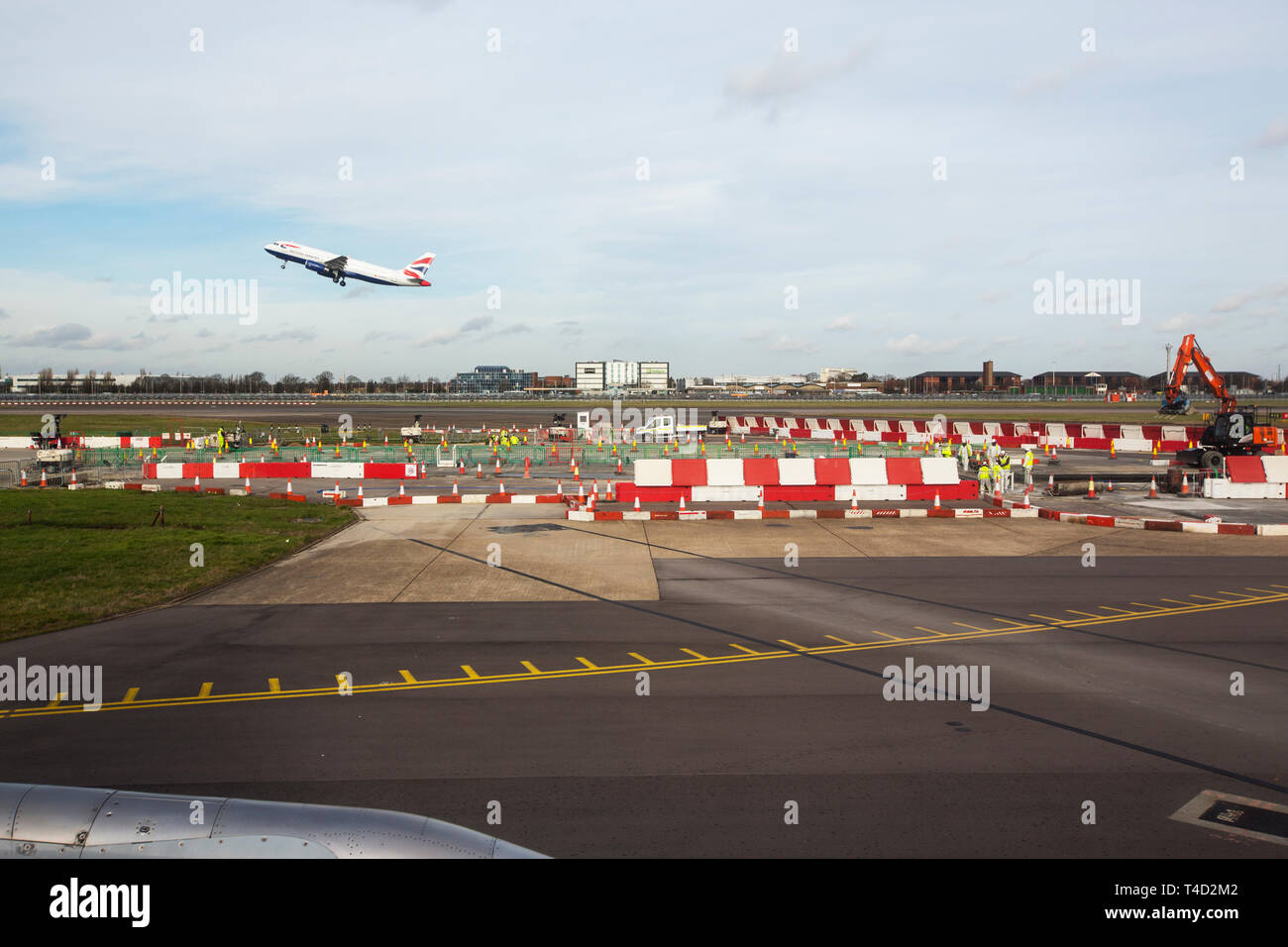Construction workers working underneath Planes taking off at Heathrow ...