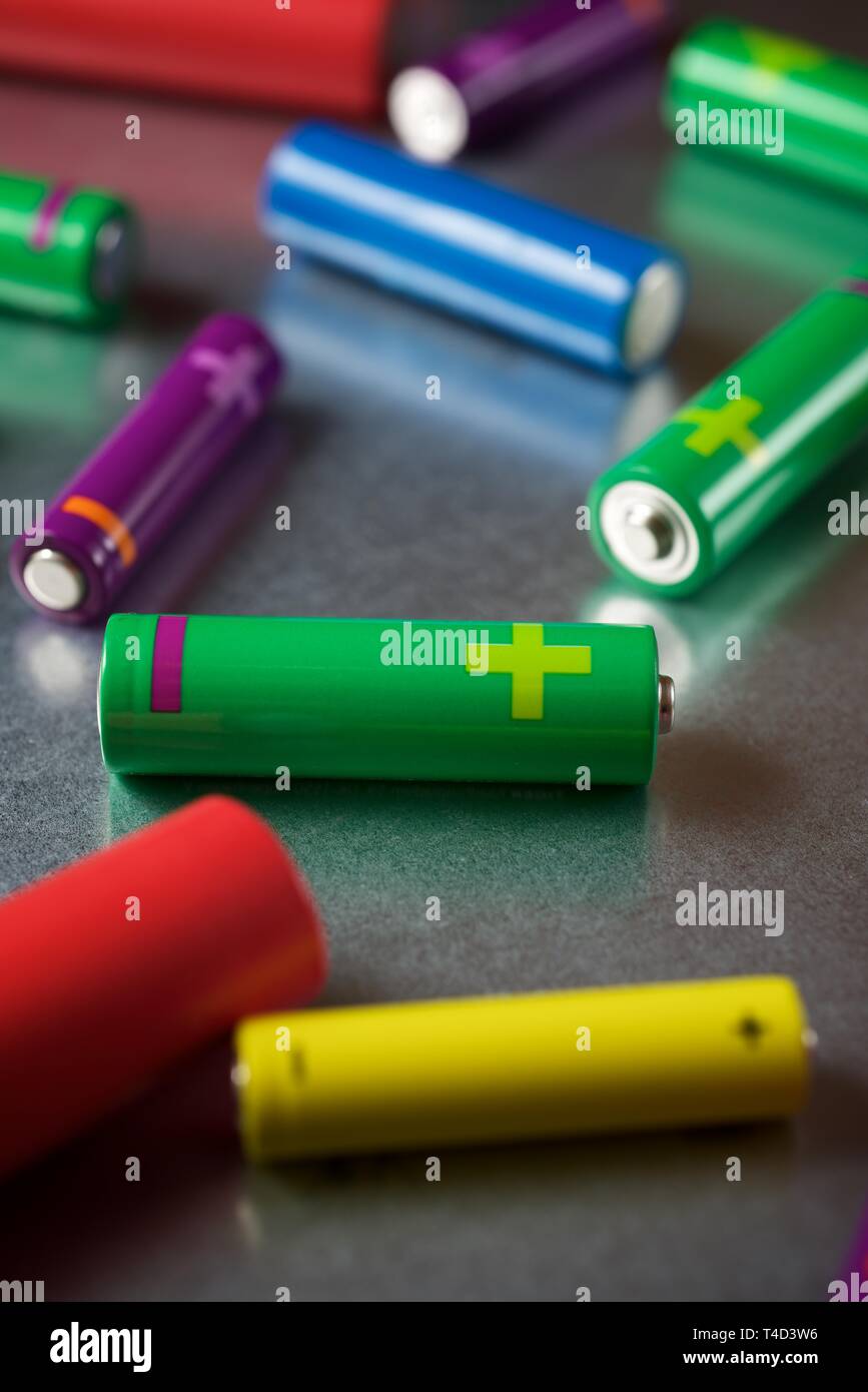 Many batteries on a metal table Stock Photo - Alamy