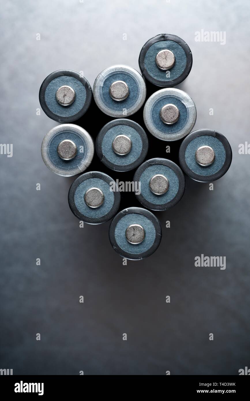 Many batteries on a metal table Stock Photo - Alamy