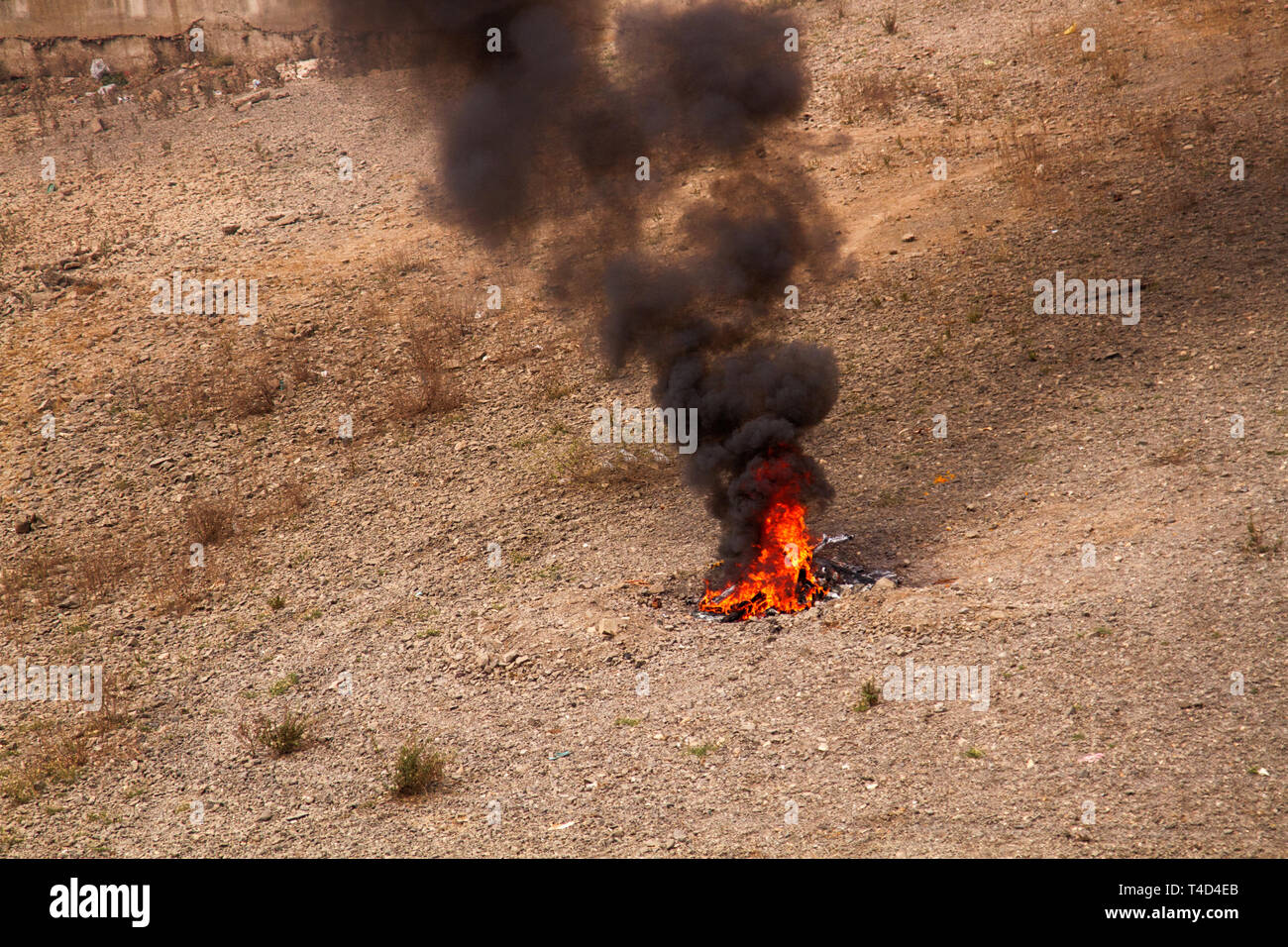 incineration of toxic waste in fire, acrid and black smoke Stock Photo ...