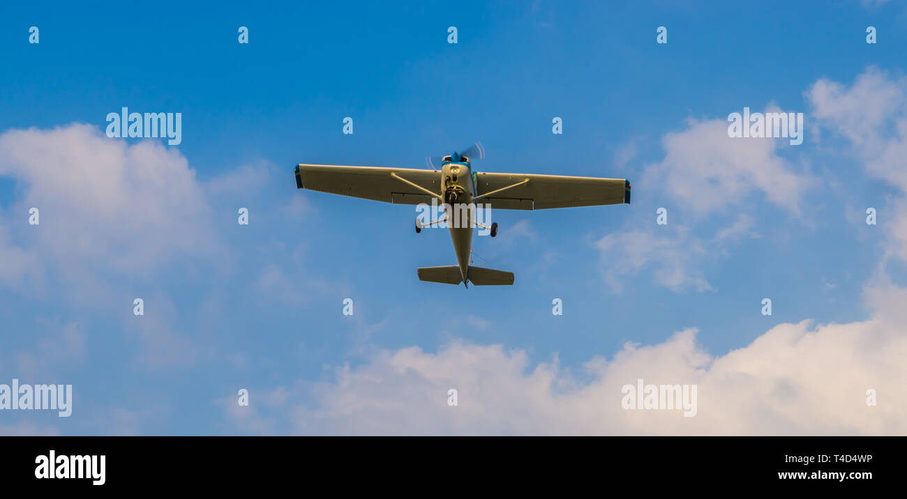 stunt airplane flying in a blue sky with clouds, air transportation ...