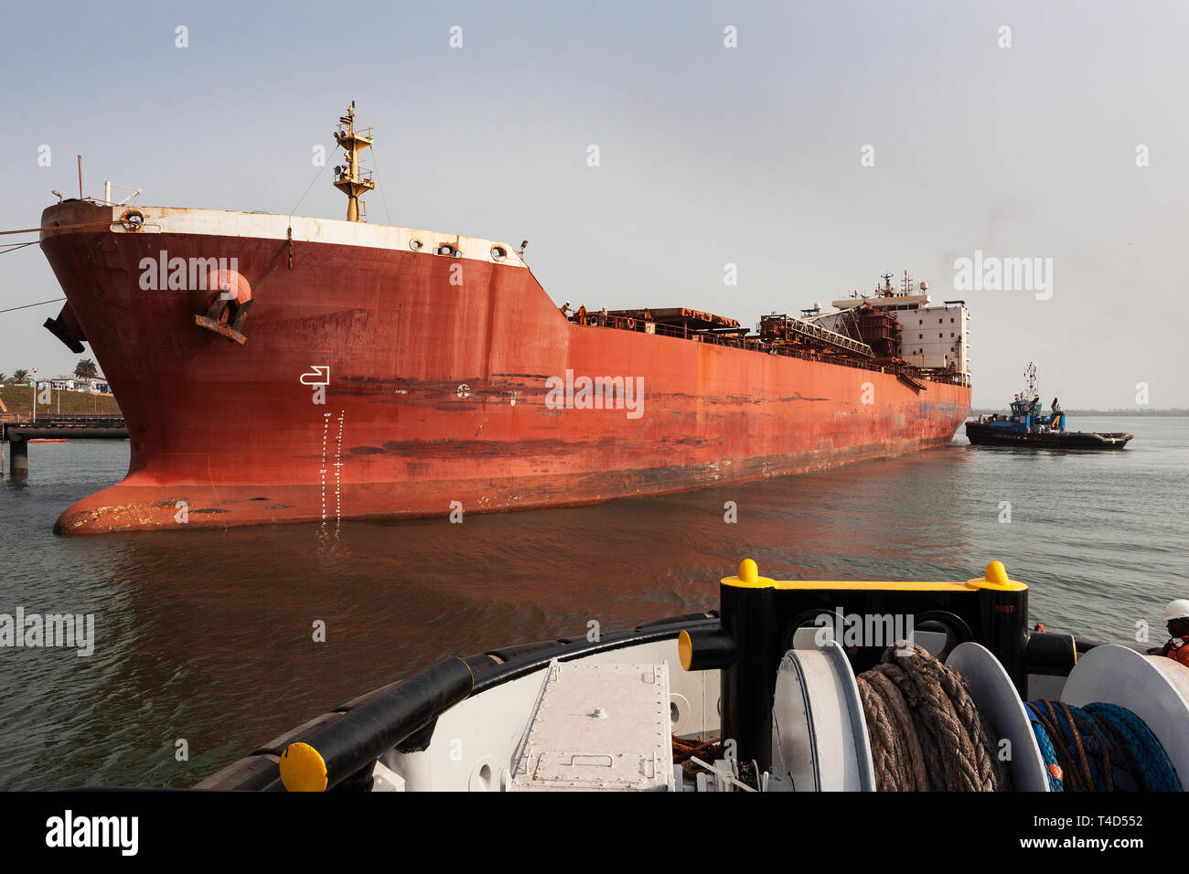 Port operations for managing and transporting iron ore. Leading tug ...