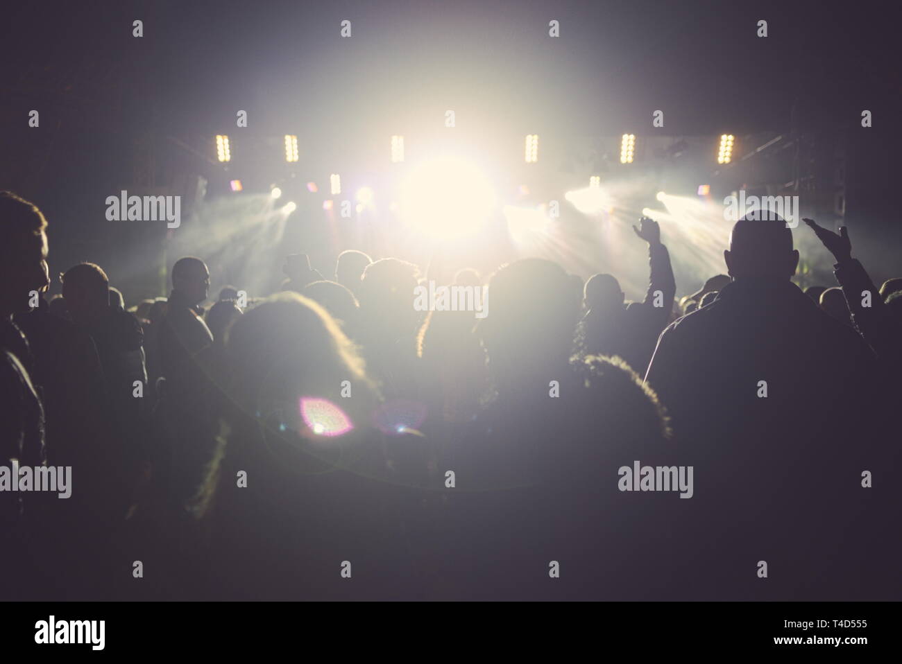 Backlit People at Concert and Strong Spotlights Stock Photo - Alamy