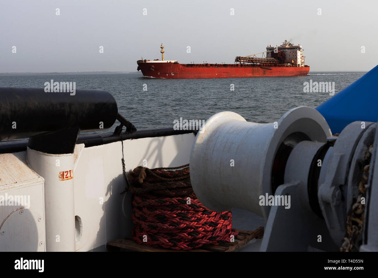 Port operations for managing & transporting iron ore. Tug escorting TGV ...