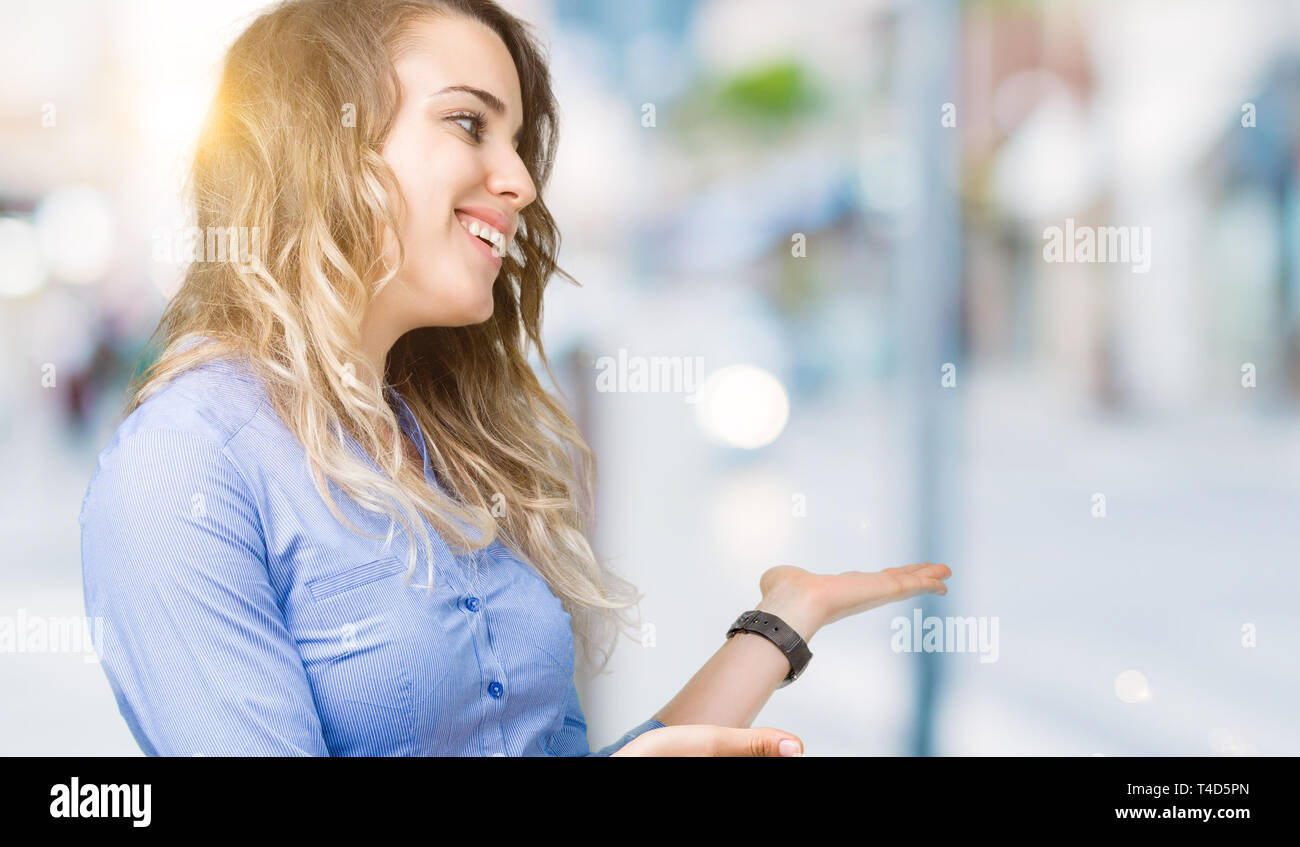 Beautiful young blonde business woman over isolated background Inviting ... Beautiful young blonde business woman over isolated background Inviting ...
