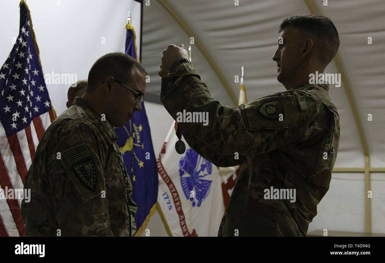 Col. Todd Erskine, 300th Sustainment Brigade commander, presents the ...