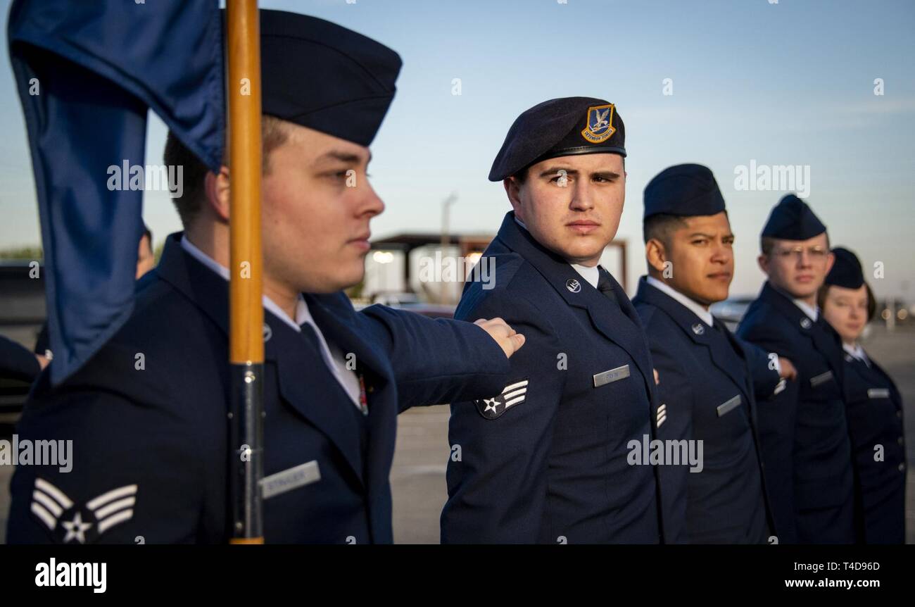 Airmen perform a dress right dress movement prior to an open ranks ...