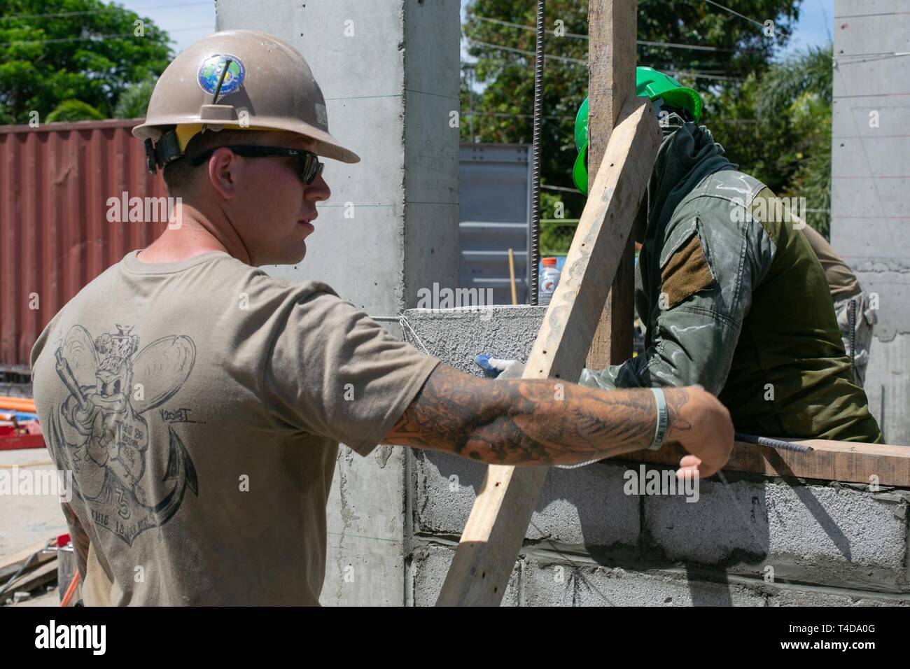 U.S. Navy Petty Officer 3rd Class Conner Lindsay assists an Armed ...