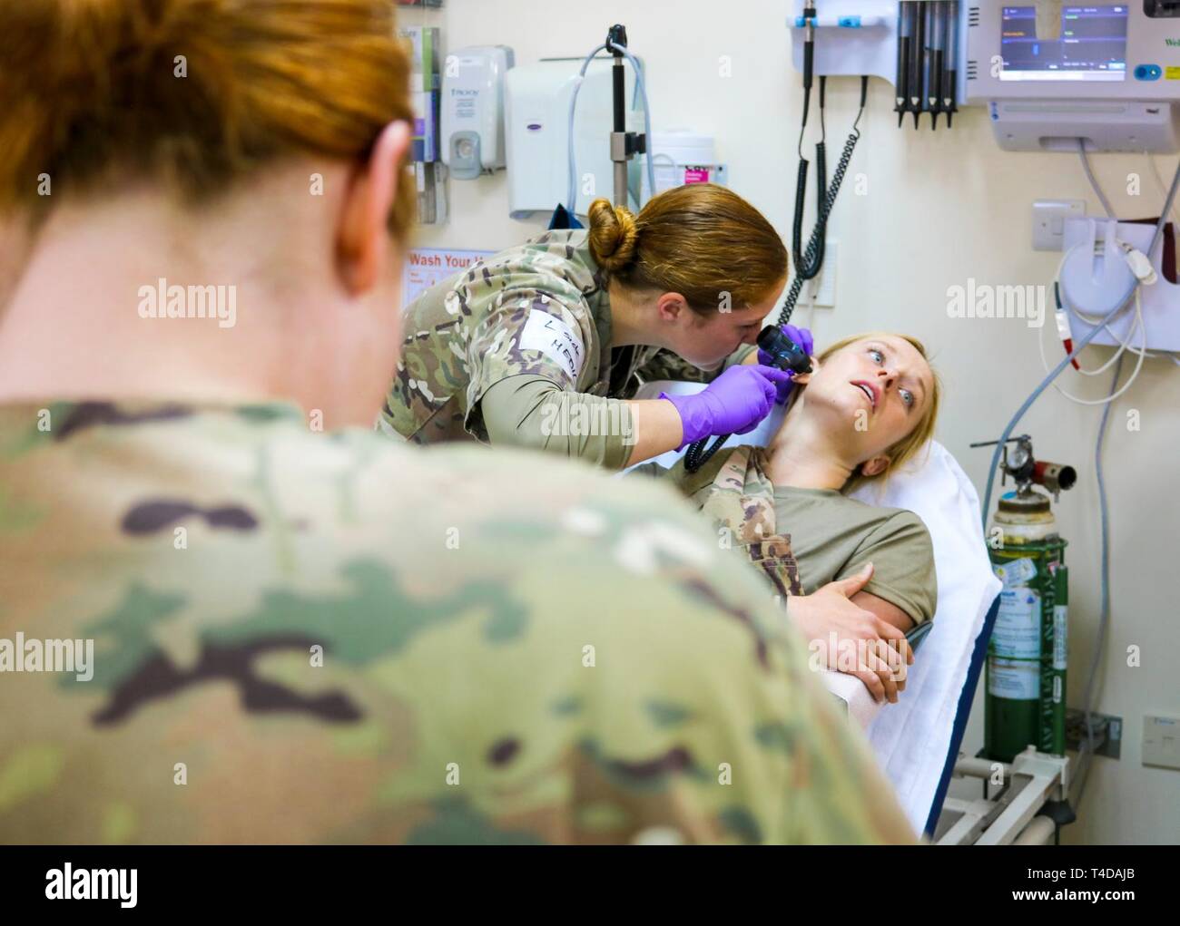 Spc. Alyson Rausch, 452d Combat Support Hospital, checks a mock ...