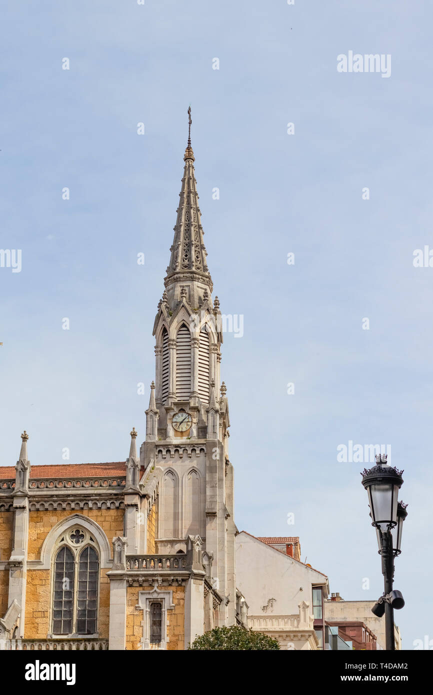 The facade of the old ancient church in Spain in the neo-gothic style ...