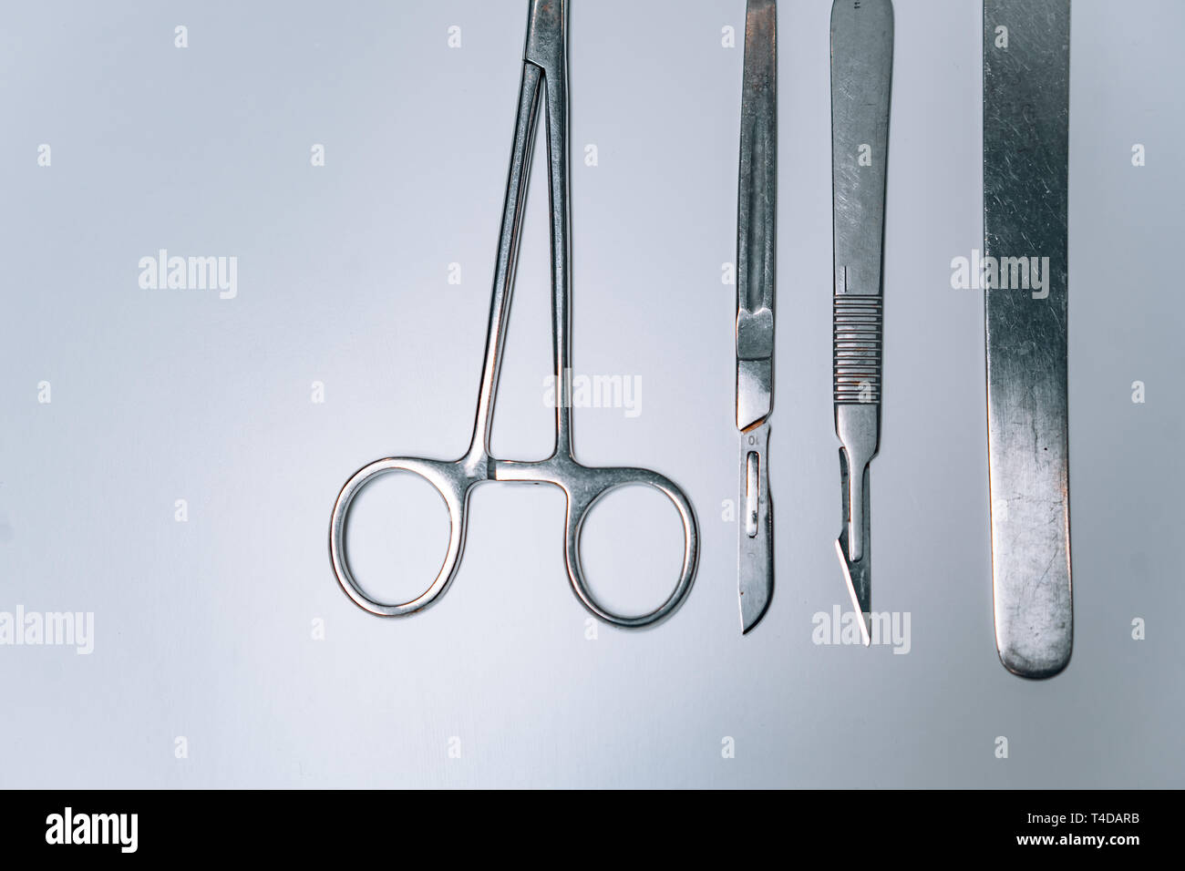 Scapula for throat, two scalpels and clamp on a light background Stock ...