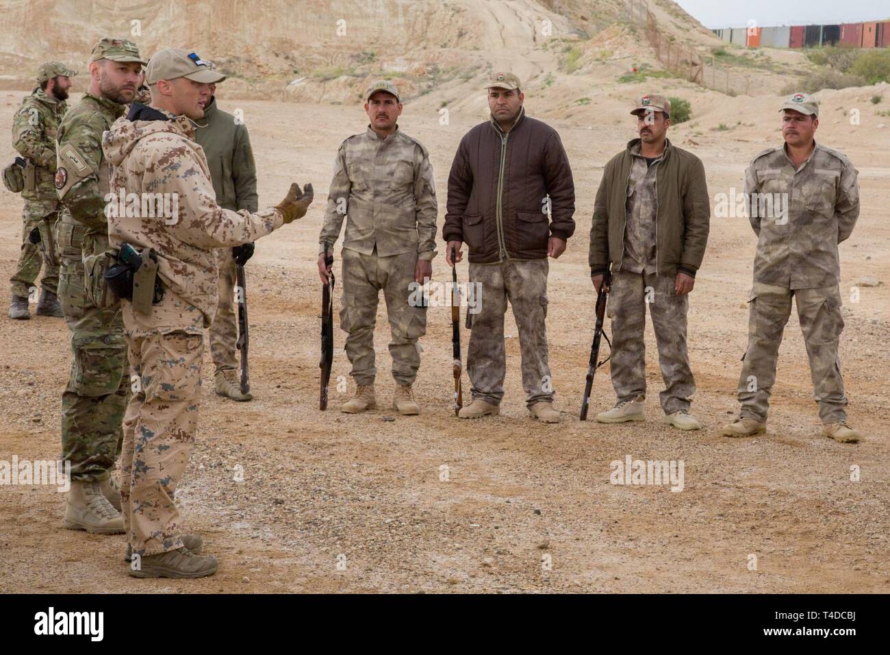 A Danish soldier teaches Iraqi soldiers the components that make up an ...