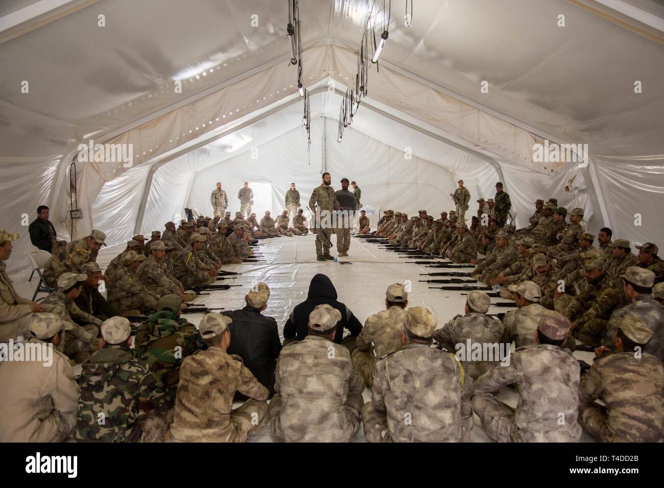 Danish soldiers teach Iraqi soldiers weapons safety in a basic weapons ...