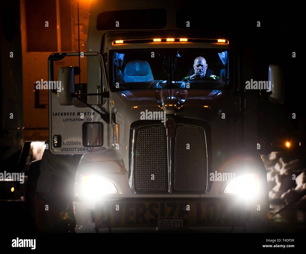 A member of Lockheed Martin helps load cargo March 19, 2019, on Buckley ...