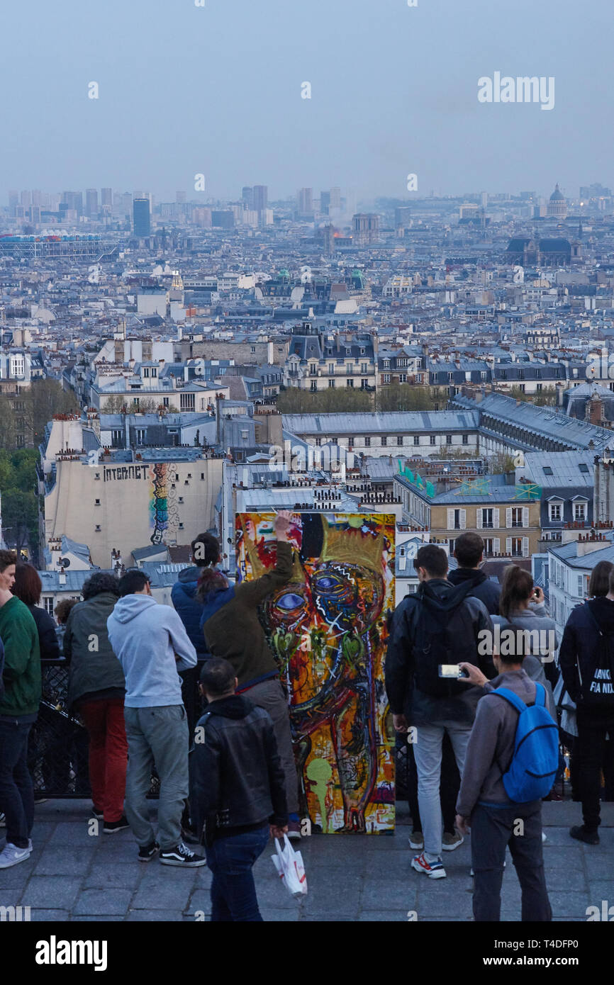 Street painter making an artwork with Fire burning at Notre Dame ...