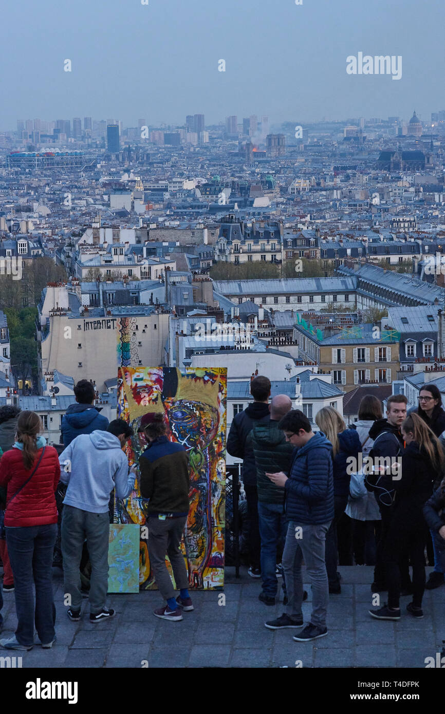 Street painter making an artwork with Fire burning at Notre Dame ...