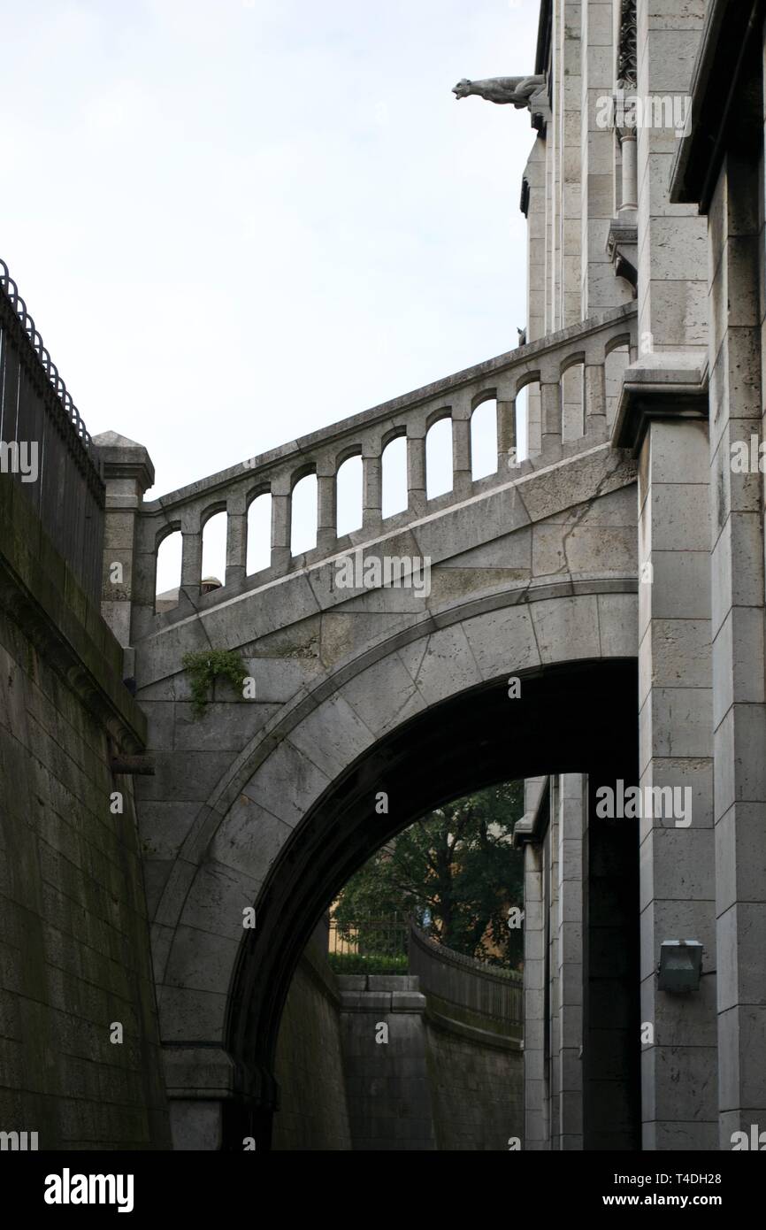 Stone archway between building and main street, over low level street ...