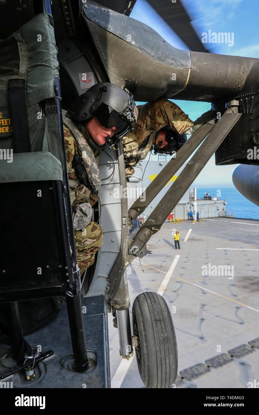 Two U.S. Army UH-60 Black Hawk helicopter crew members, assigned to the ...