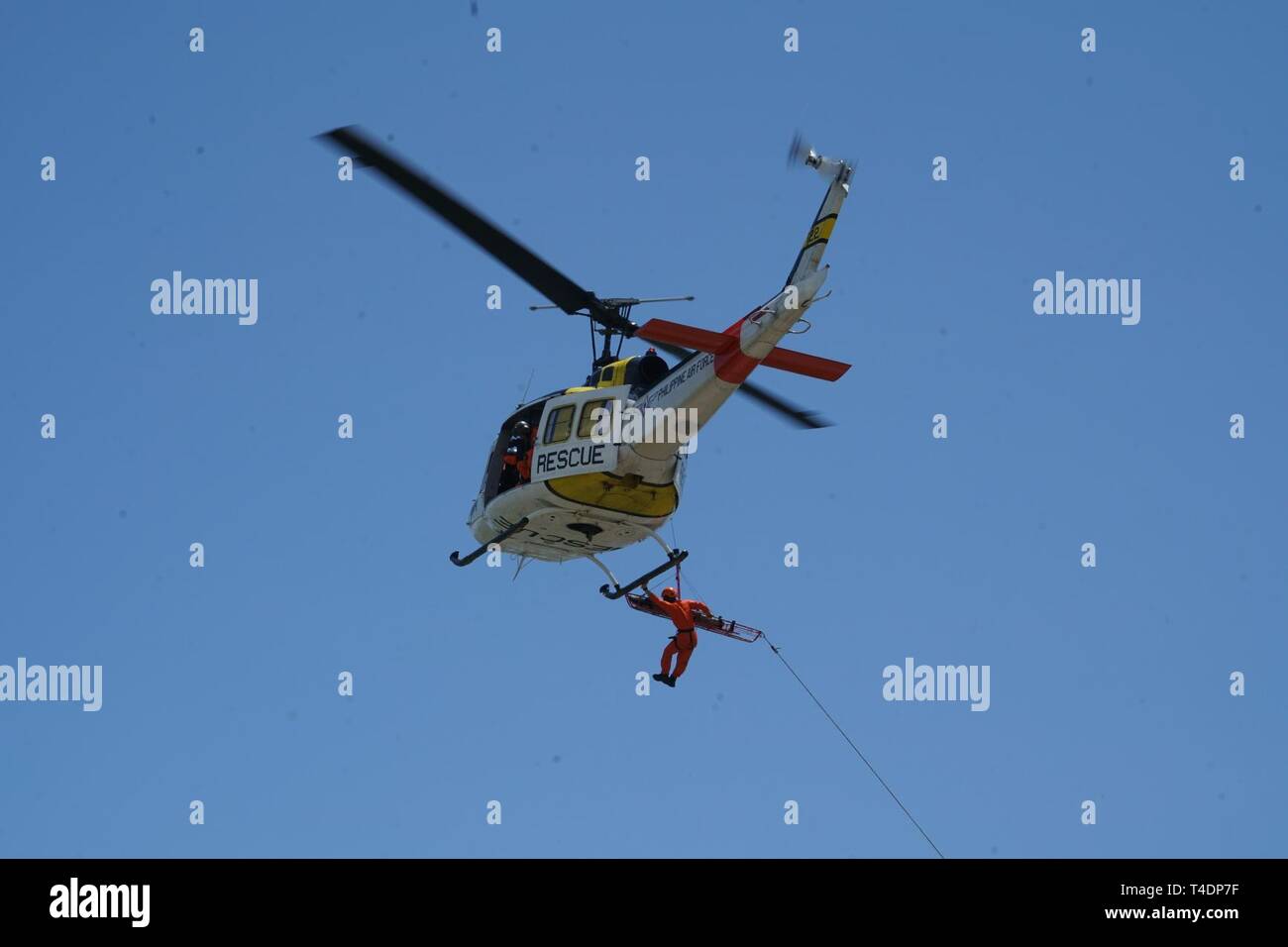 A Philippine Fire Department rescue worker lifts a simulated earthquake ...