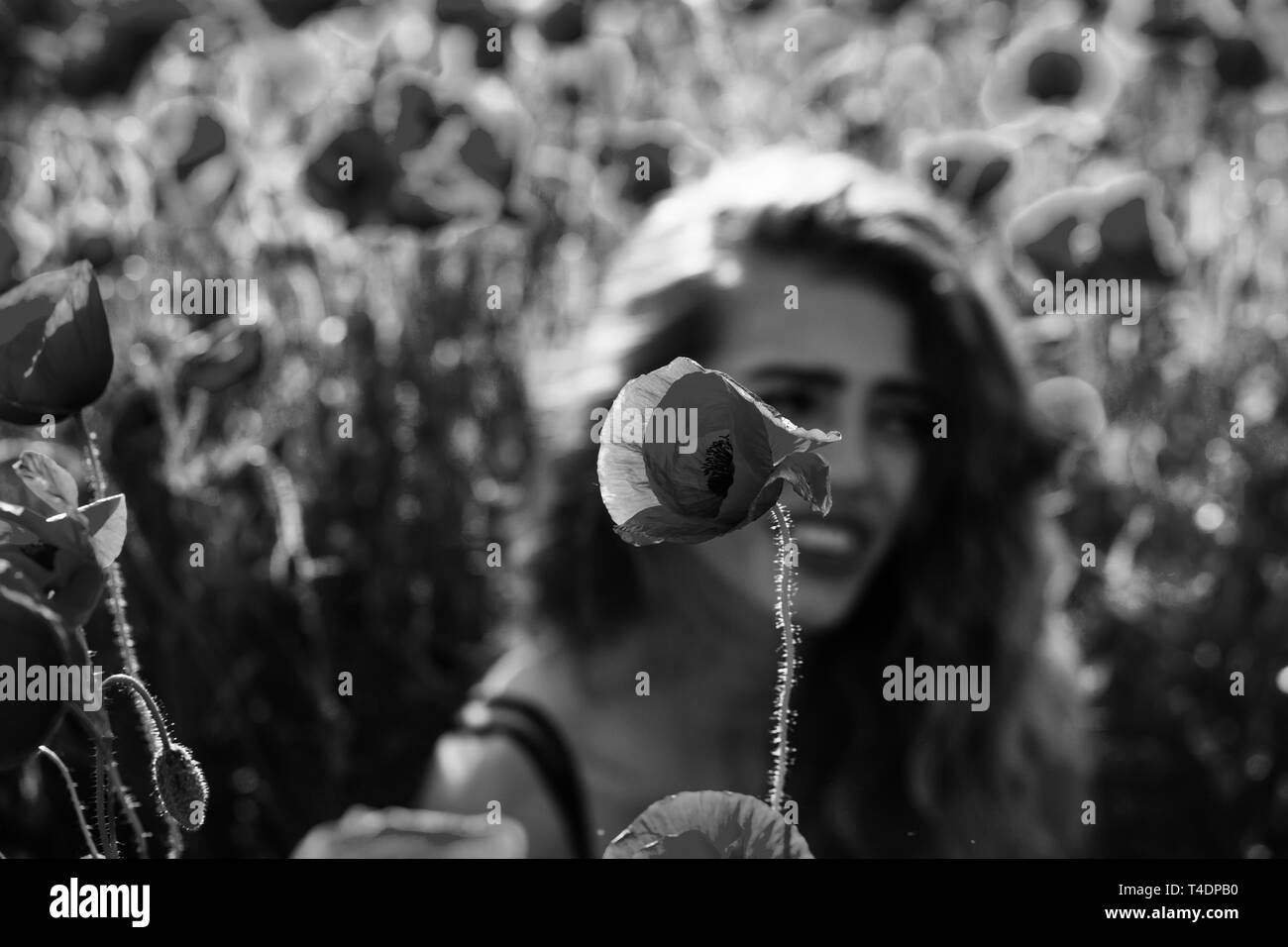 poppy seed at girl with long curly hair Stock Photo - Alamy