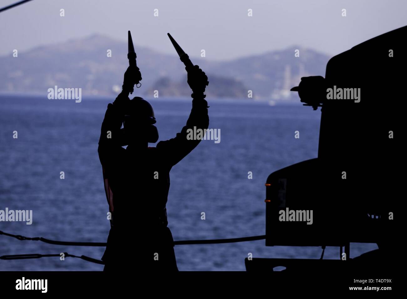 U.S. Marine Corps Gunnery Sgt. Jerry Brumfield ground guides a vehicle ...