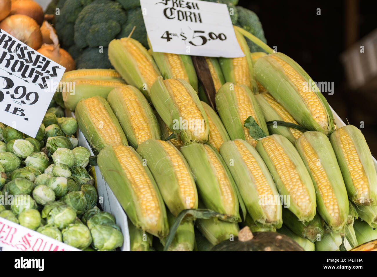 Corn cobs and brussels sprouts at a stall at Seattle's Pike Place ...