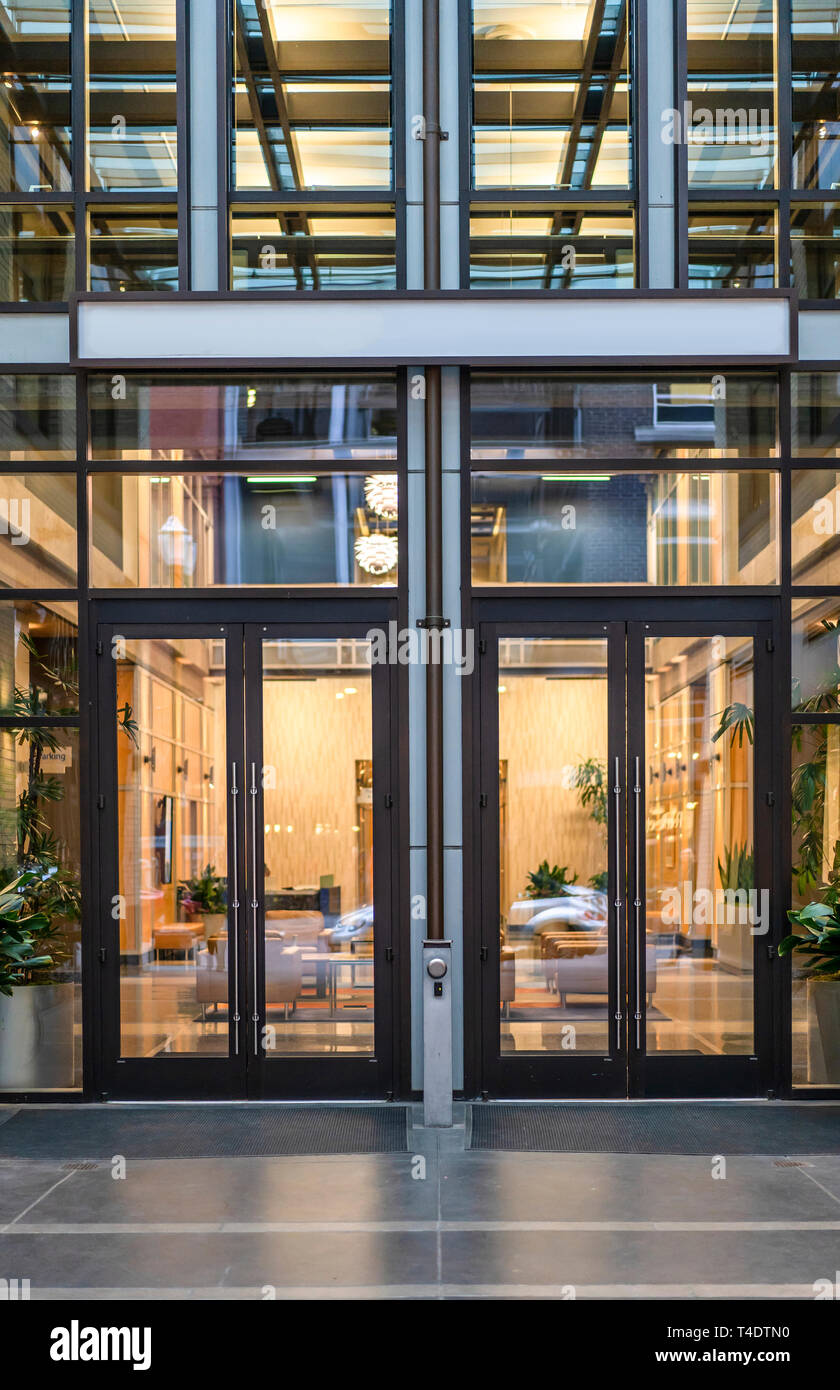 Symmetrical entrance door to the lobby of a skyscraper building with ...